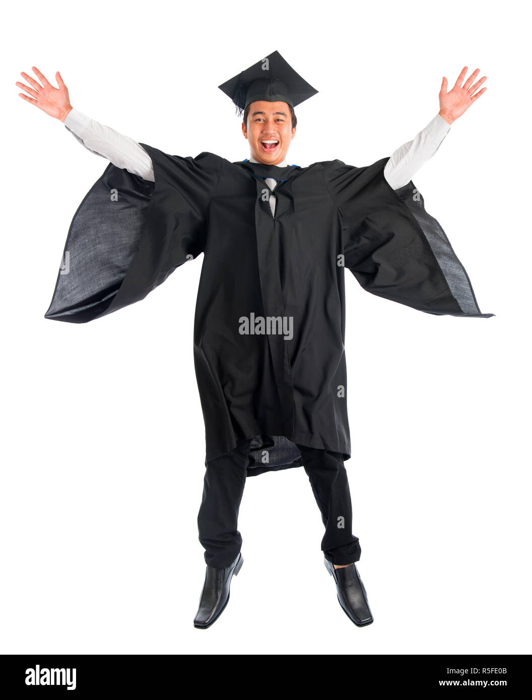 Graduate university student jumping high Stock Photo - Alamy