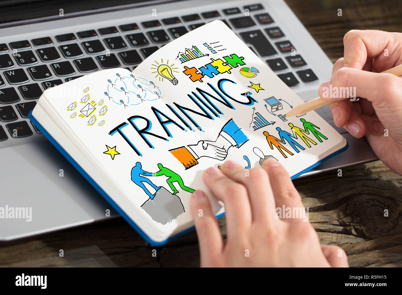 Business Person Drawing Training Chart On Notebook Stock Photo - Alamy