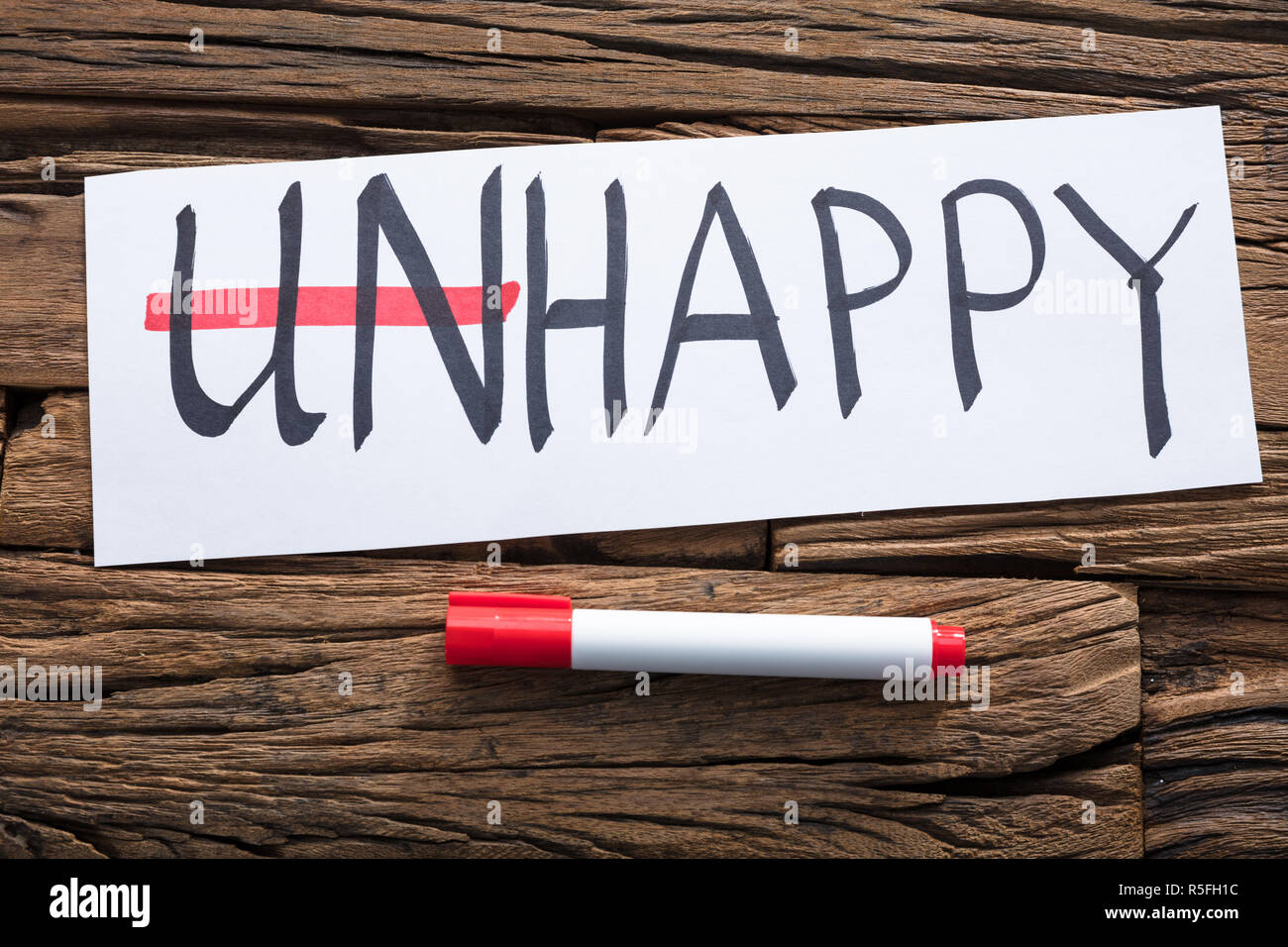 Unhappy Word On Paper With Strike Out Un Text Stock Photo - Alamy