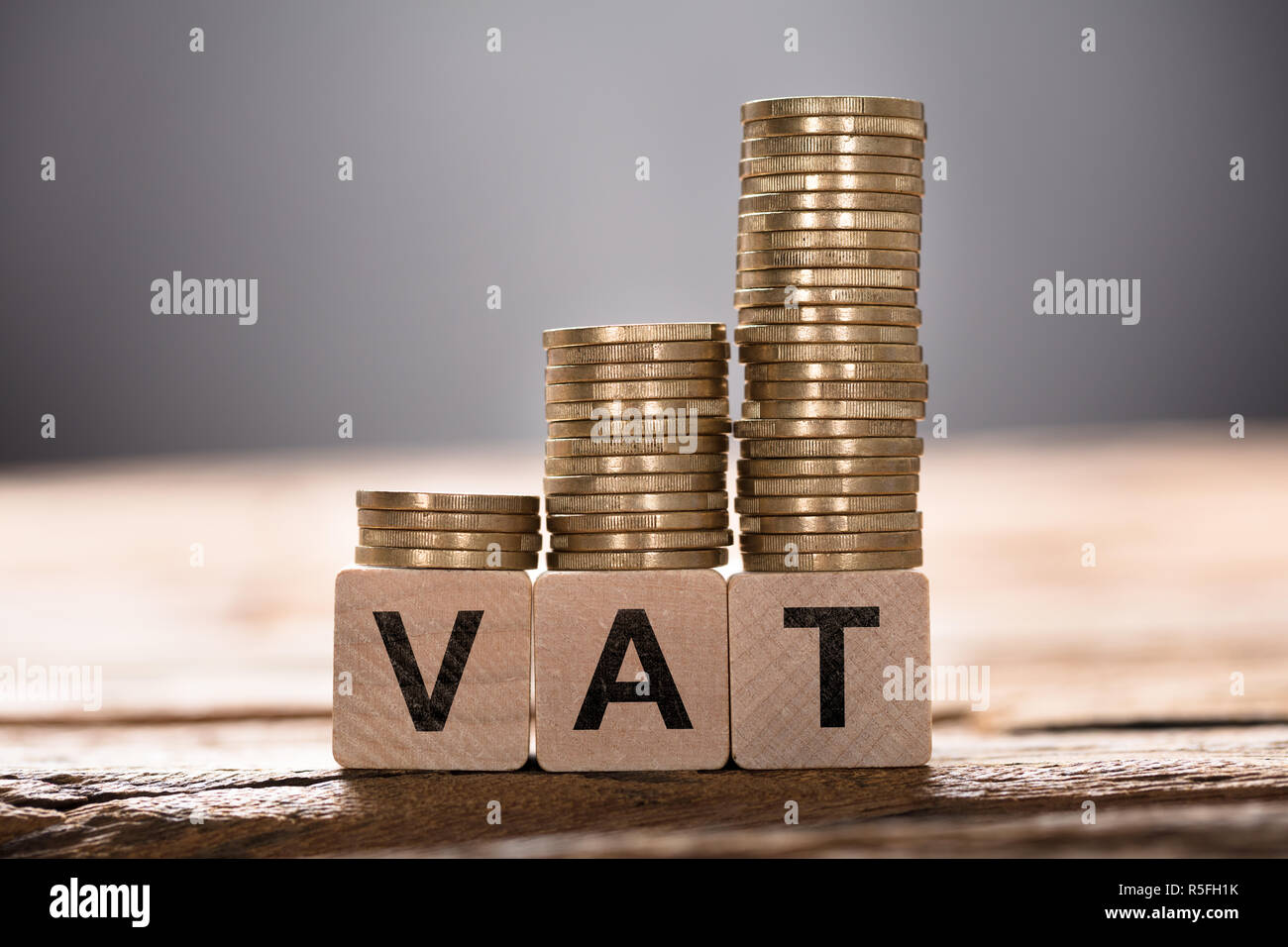 Vat Text Written On Wooden Blocks With Stacked Coins Stock Photo - Alamy
