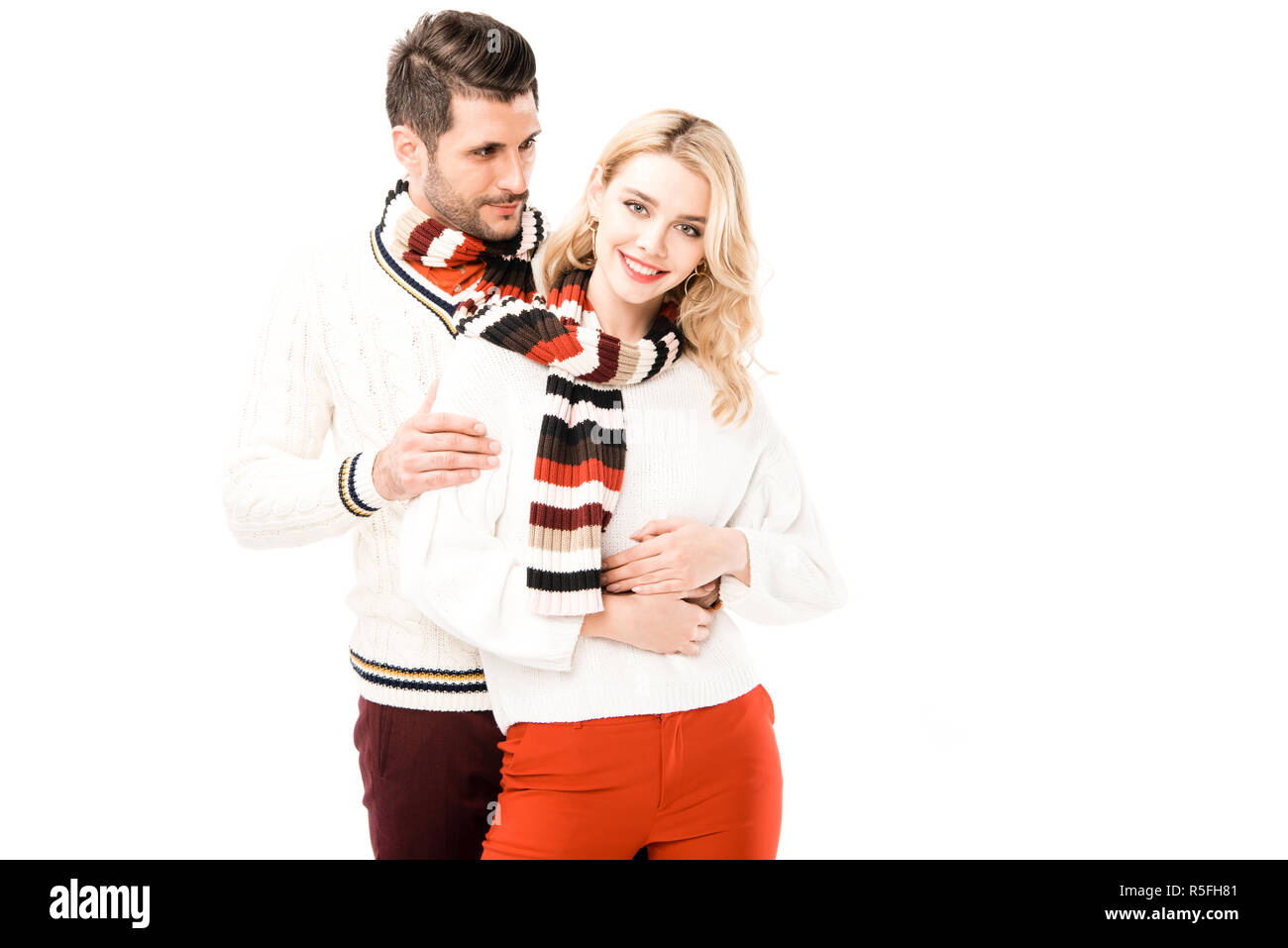 Romantic couple in knitted scrafs hugging isolated on white Stock Photo ...
