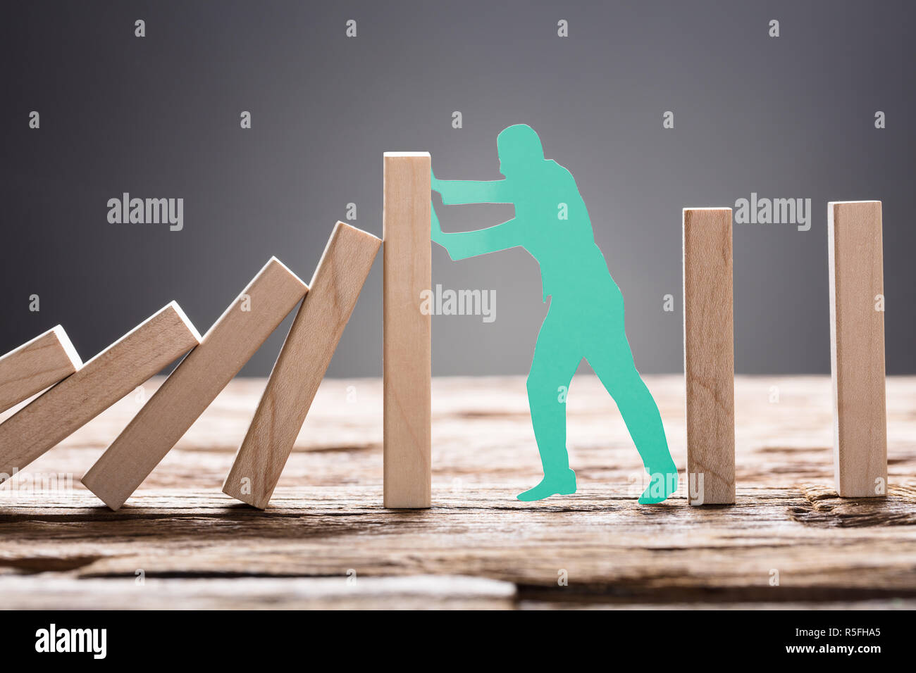 Domino piece stopping effect hi-res stock photography and images - Alamy