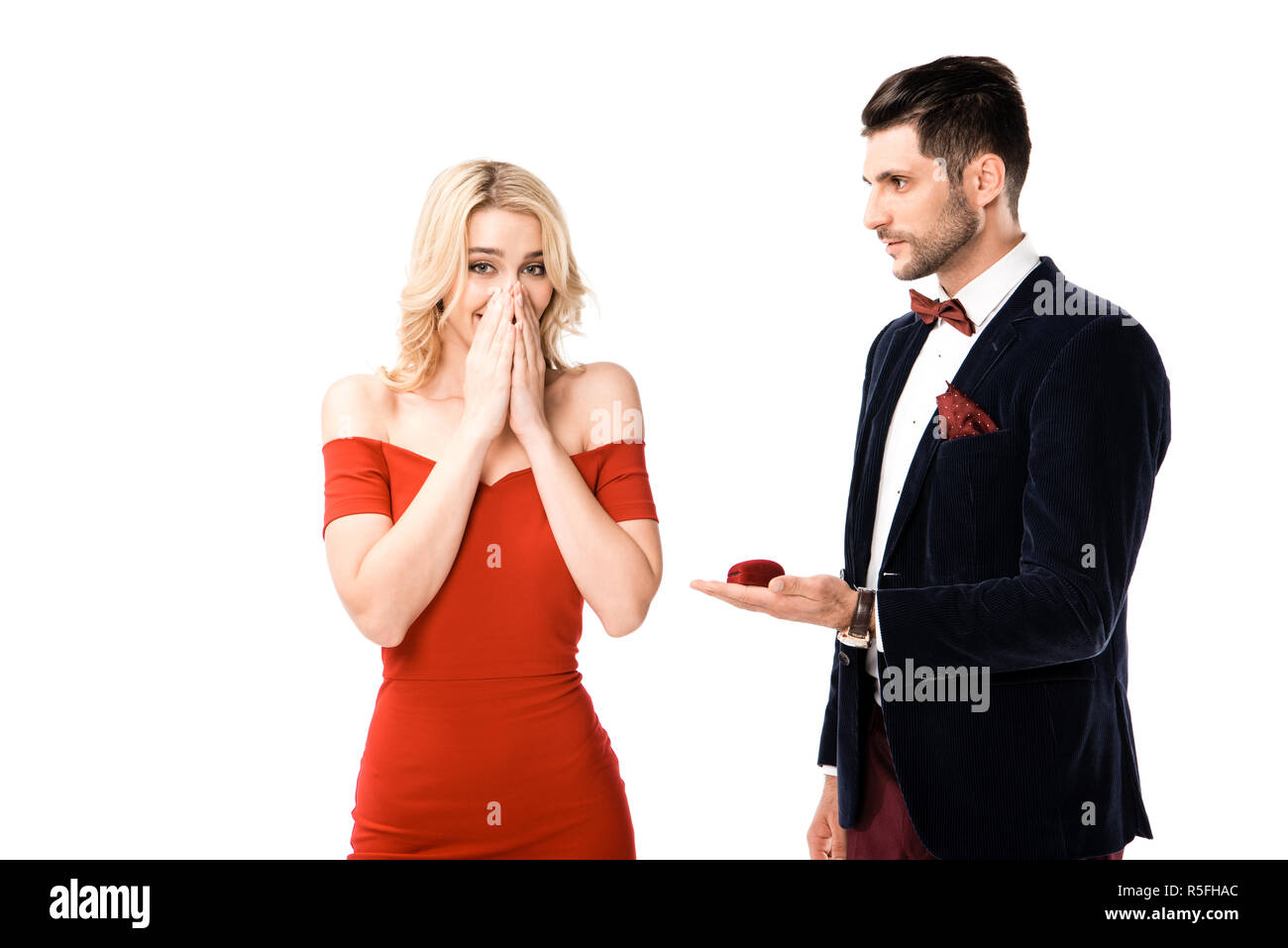 Handsome man proposing surprised girlfriend to marry isolated on white ...