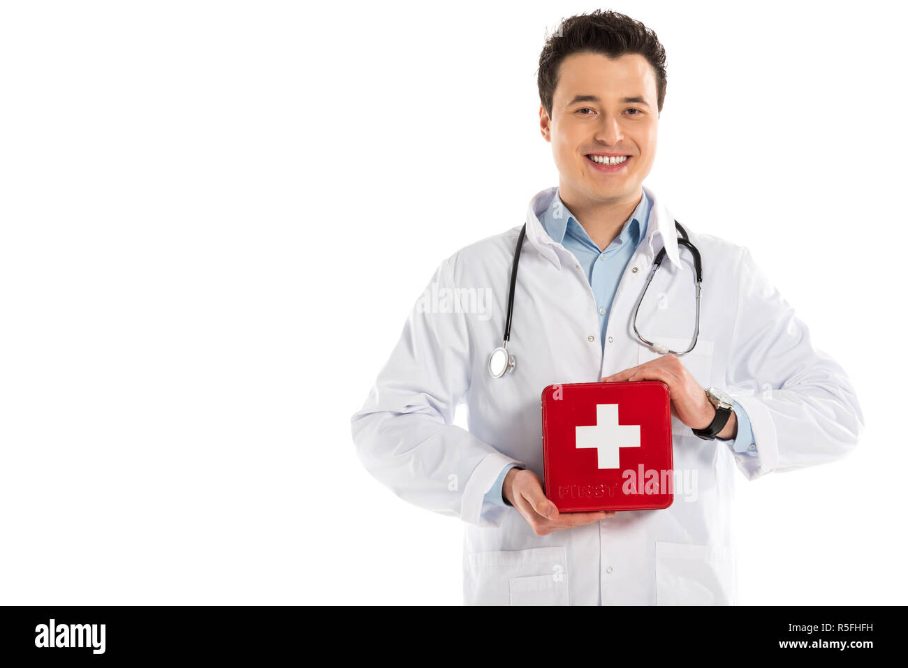 handsome male doctor holding first aid kit and looking at camera ...