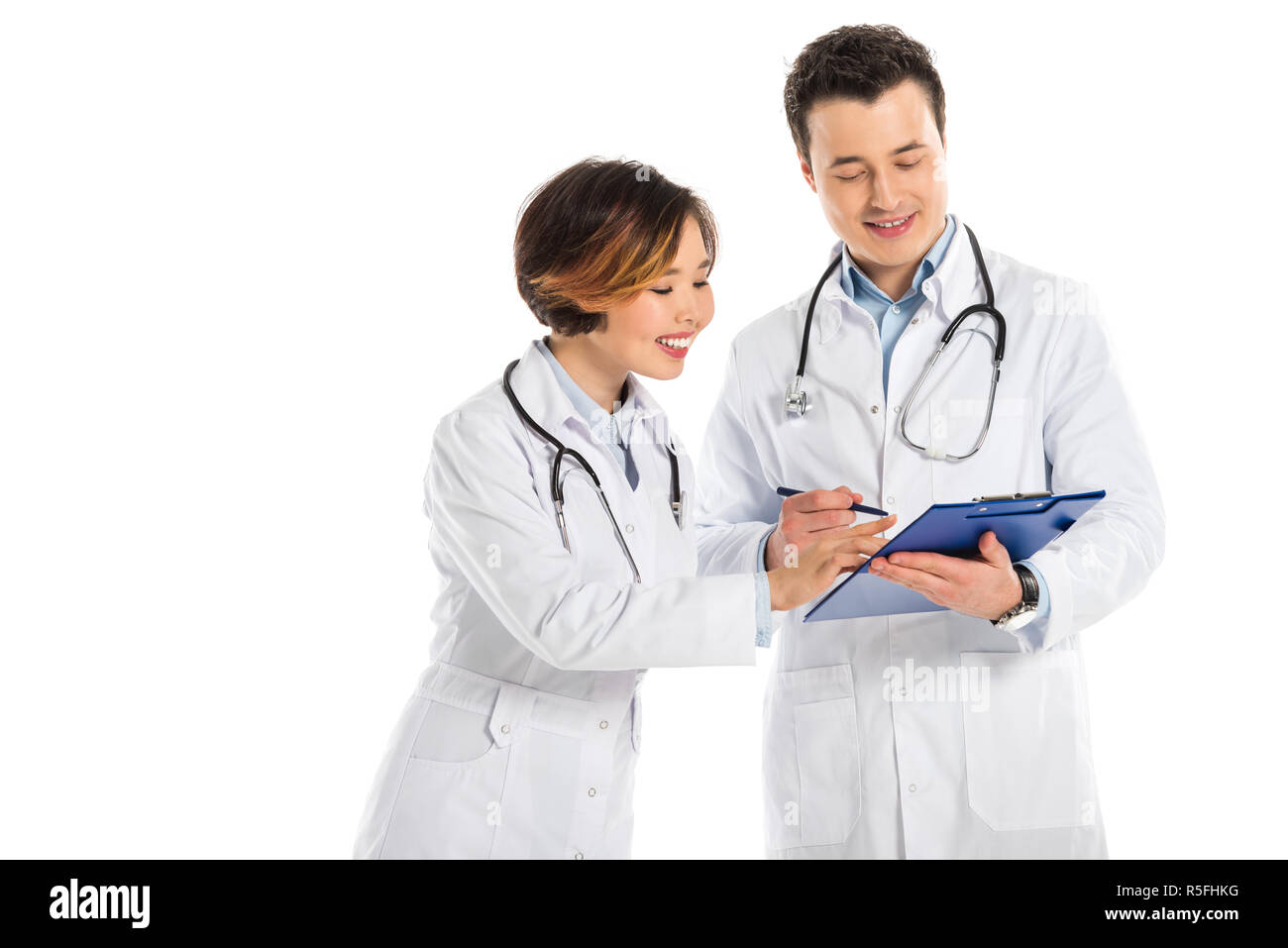 smiling female and male doctors discussing diagnosis isolated on white ...