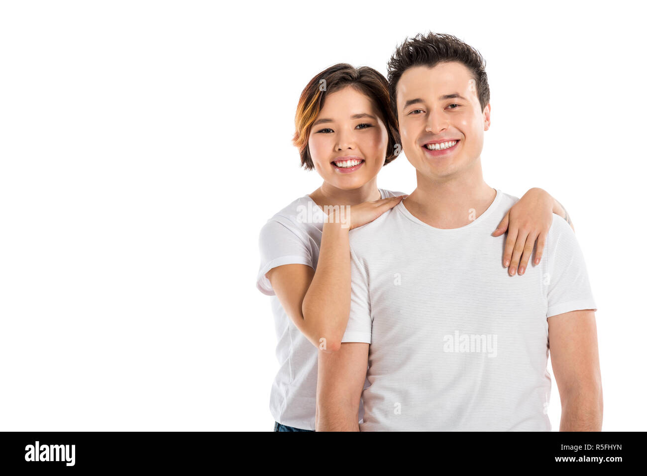 portrait of loving couple hugging and looking at camera isolated on ...