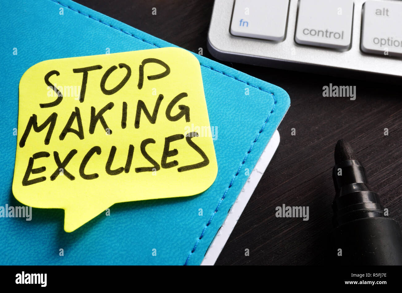 Stop making excuses written on a piece of paper Stock Photo - Alamy