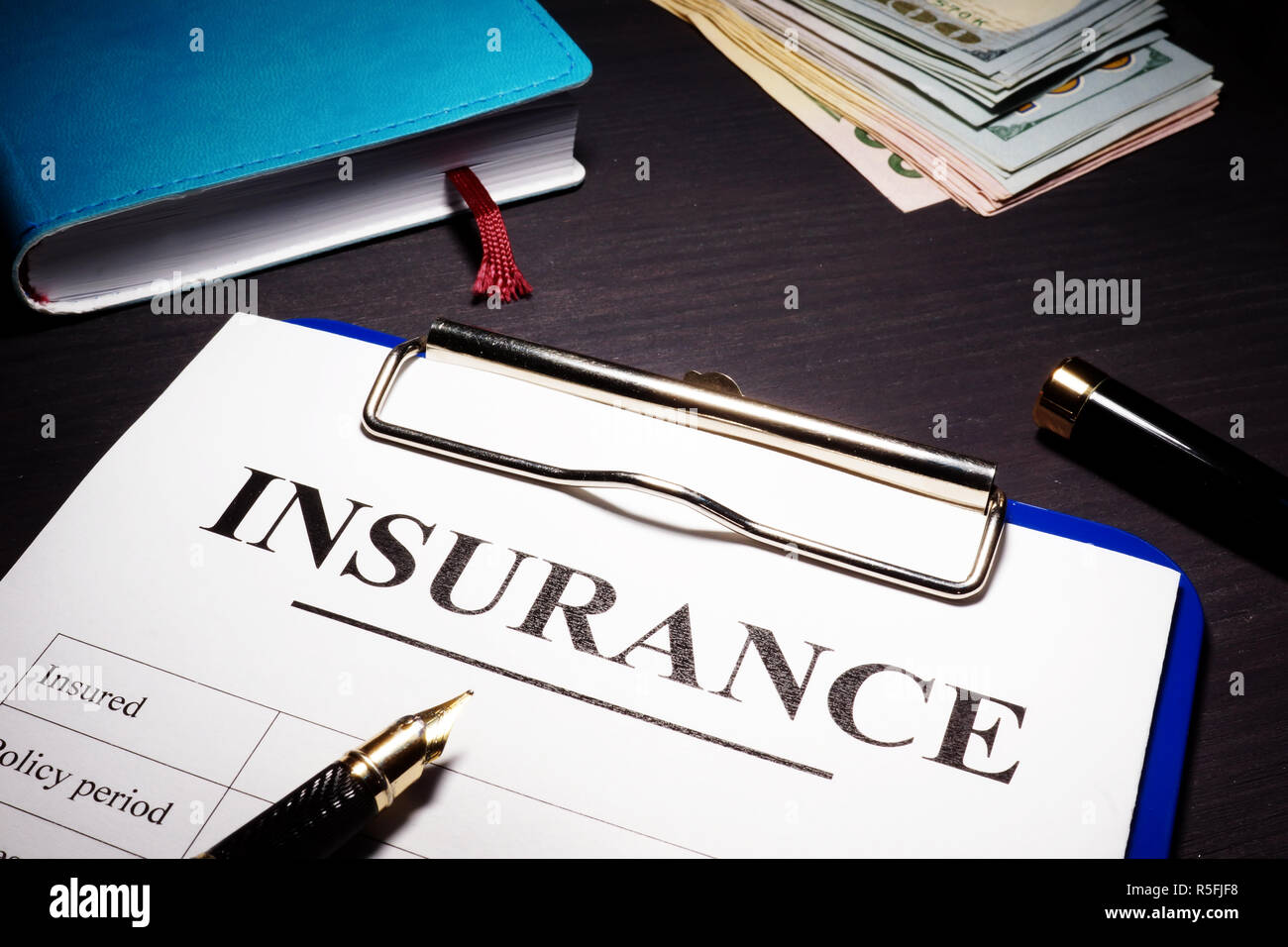 Insurance policy form and pen on a desk Stock Photo - Alamy