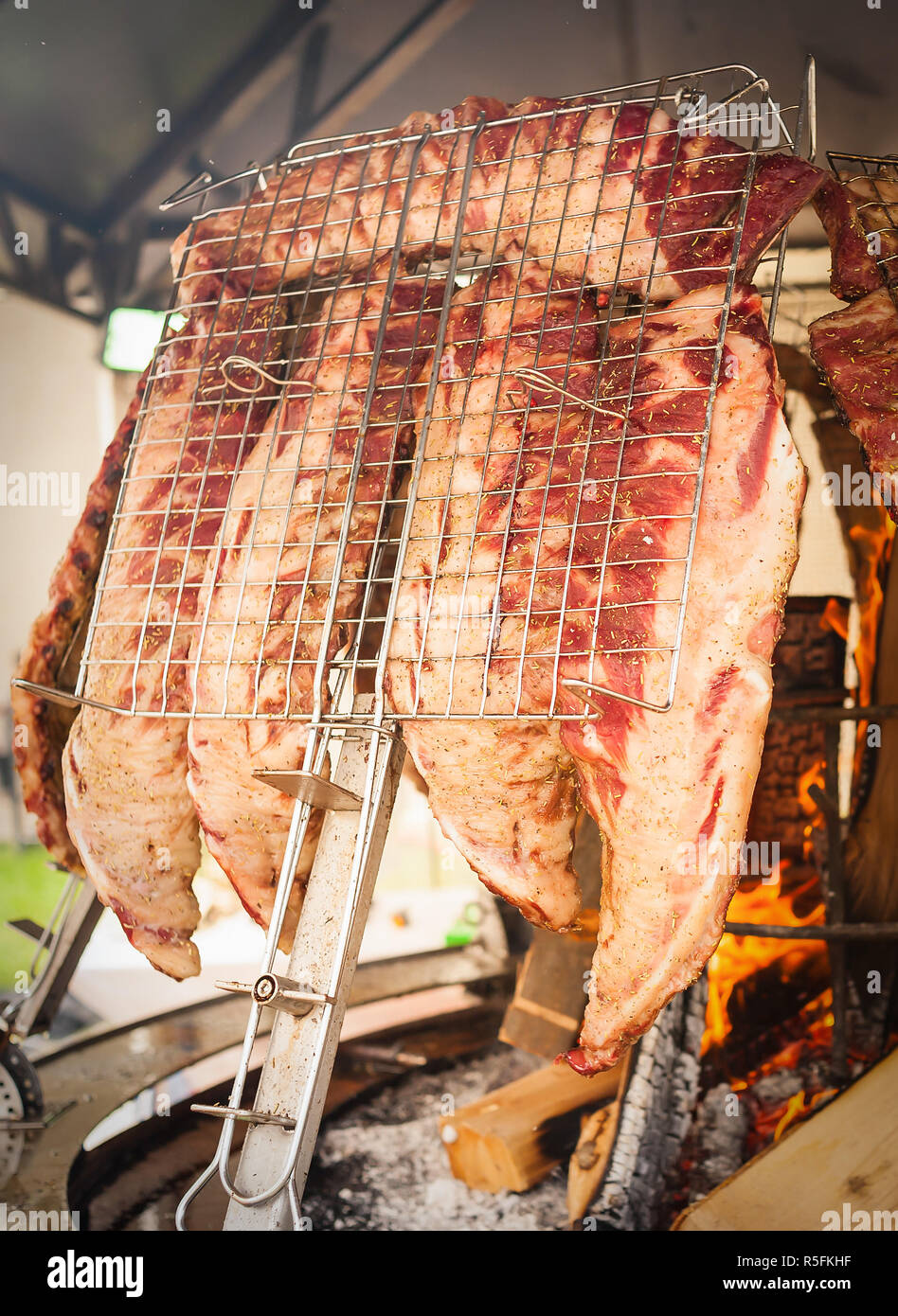 Roasted meat of beef cooked on a vertical grills Stock Photo - Alamy