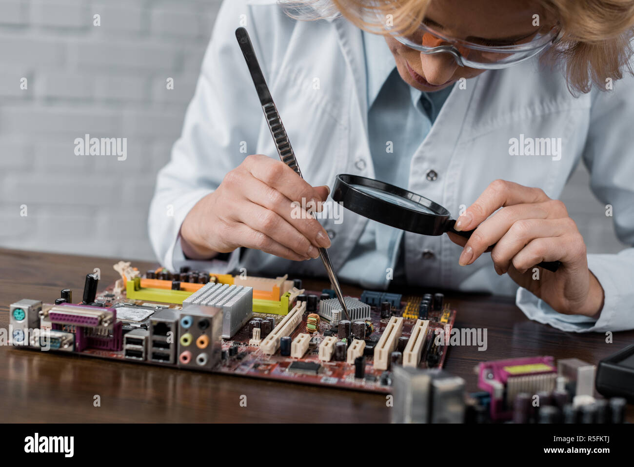 close-up shot of concentrated female computer engineer repairing ...