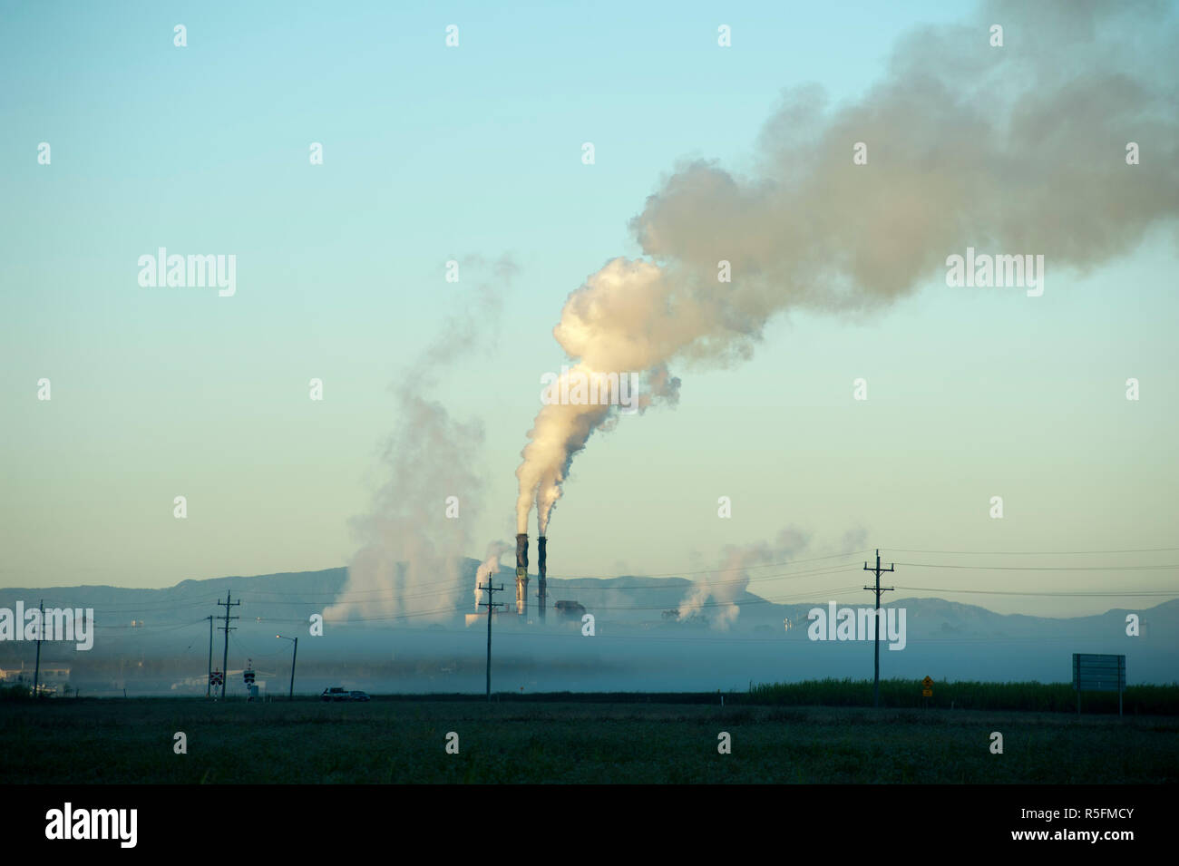 View of sugar processing plant behind fog Stock Photo - Alamy