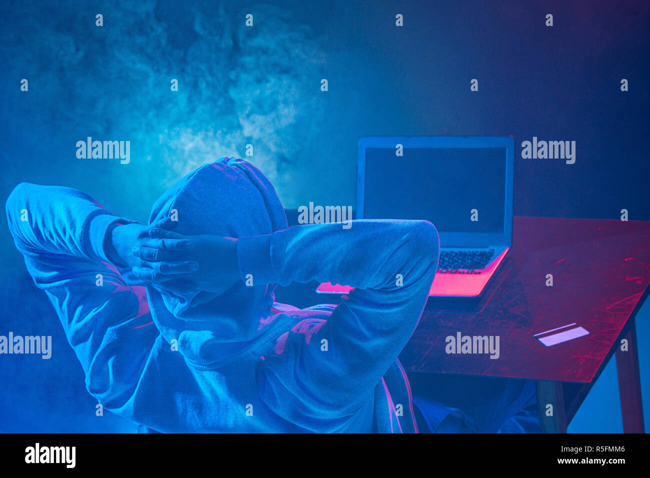 Hooded computer hacker stealing information with laptop Stock Photo - Alamy