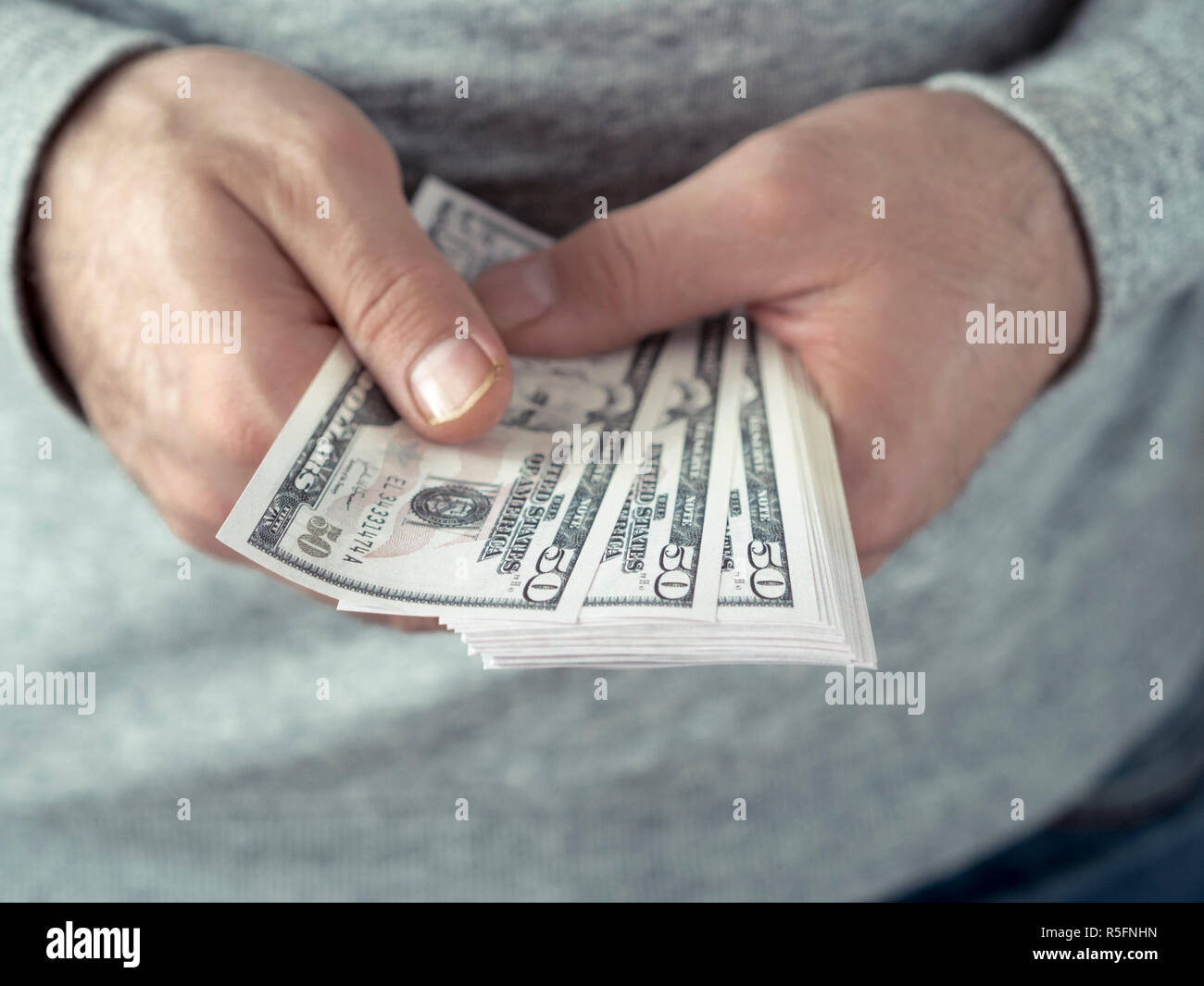 Hands counting dollars Stock Photo - Alamy