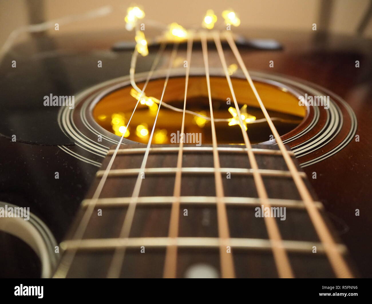 Star light string hanging on strings of a acoustic guitar Stock Photo ...