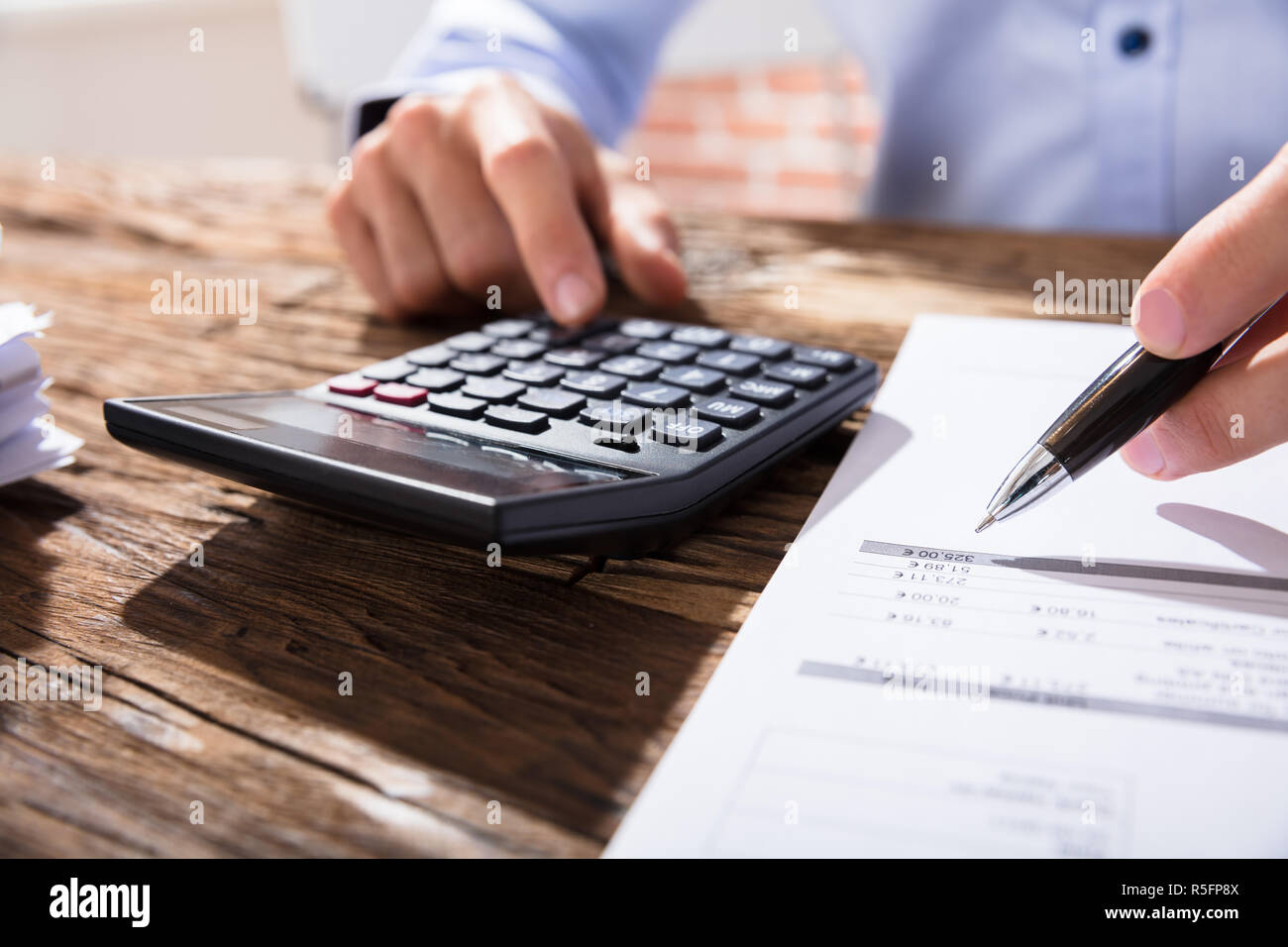Person Calculating Finance Using Calculator Stock Photo - Alamy