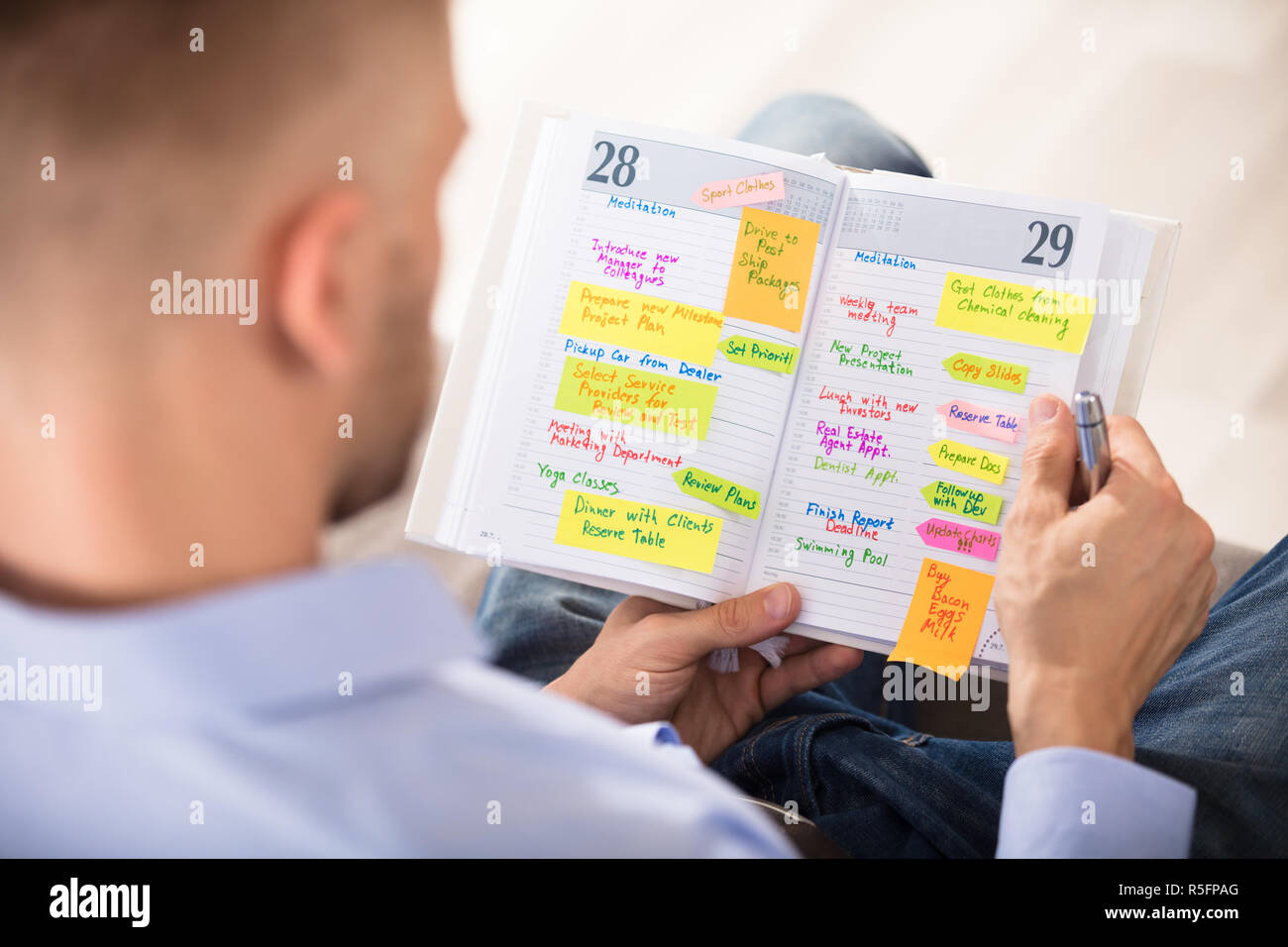Man Writing Important Notes In Diary Stock Photo - Alamy
