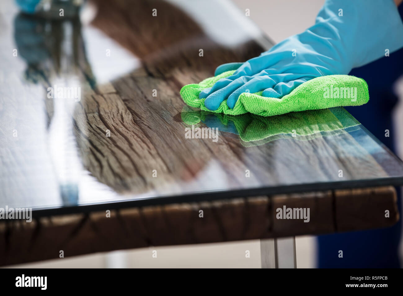 Janitor's Hand Cleaning Desk With Cloth Stock Photo - Alamy