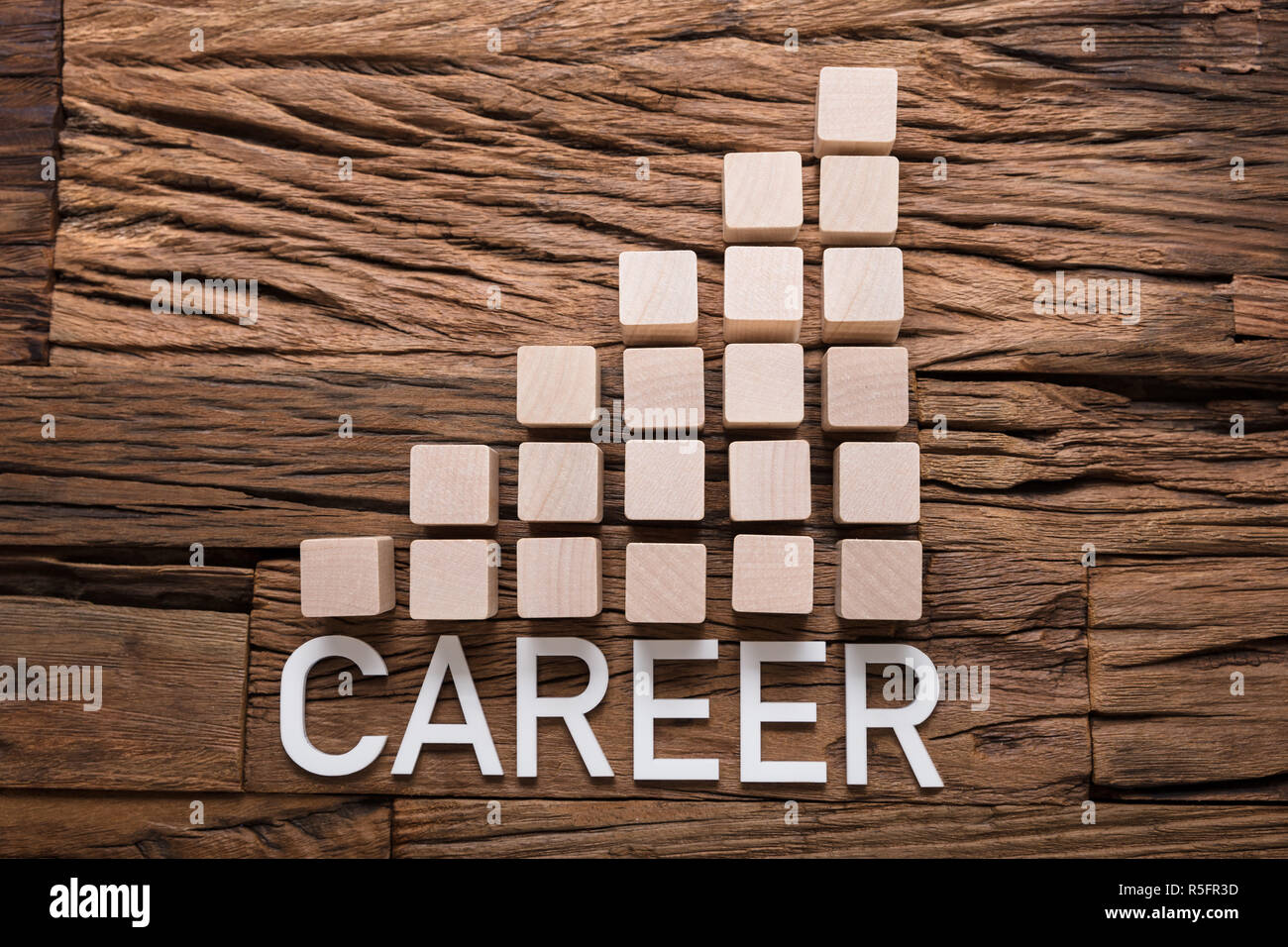 Career Text By Increasing Bar Graph Blocks On Wood Stock Photo - Alamy