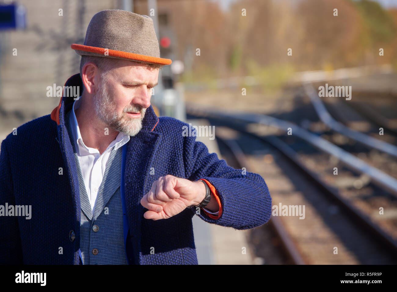 Businessman checking watch waiting train hi-res stock photography and ...