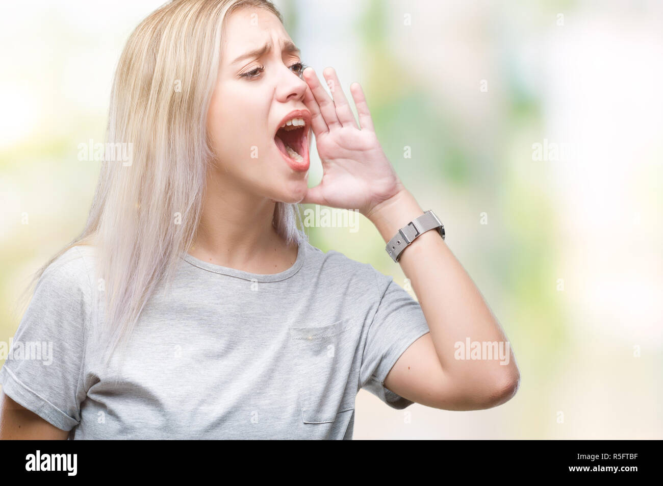 Young blonde woman over isolated background shouting and screaming loud ...