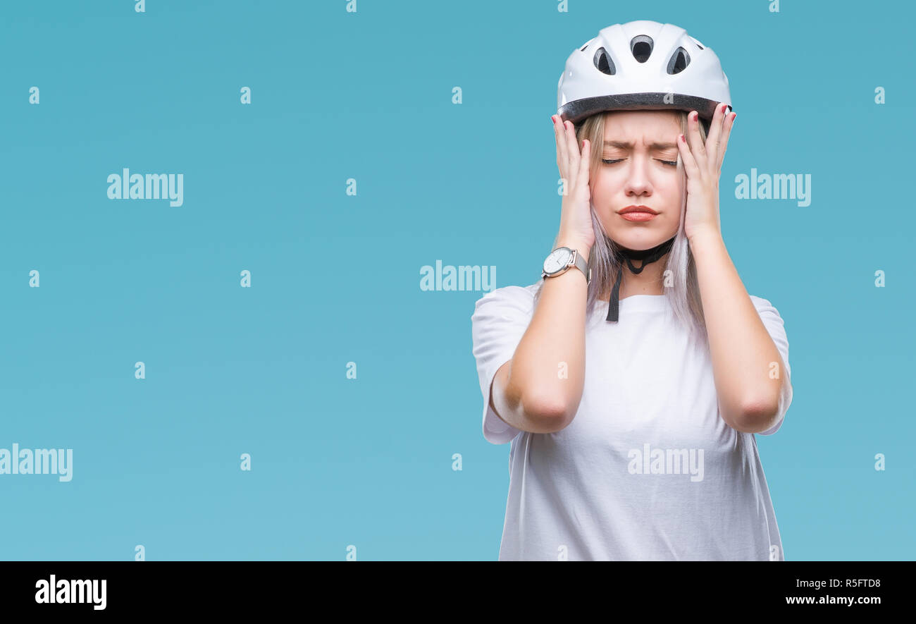 Young blonde woman wearing cyclist security helmet over isolated ...