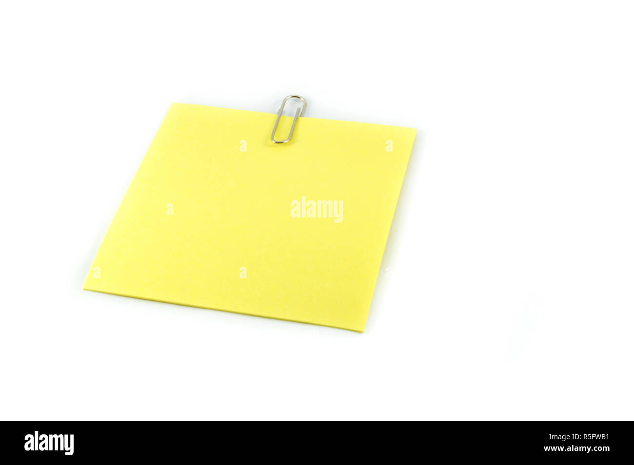 paper clip pin on white / yellow stick note paper with clip isolated on ...