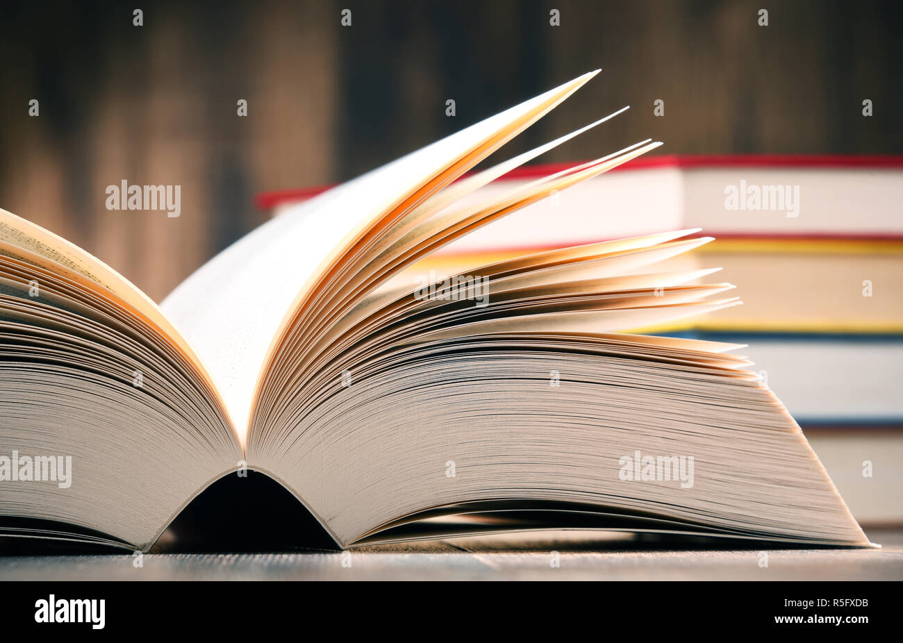 Composition with open book on the table Stock Photo - Alamy