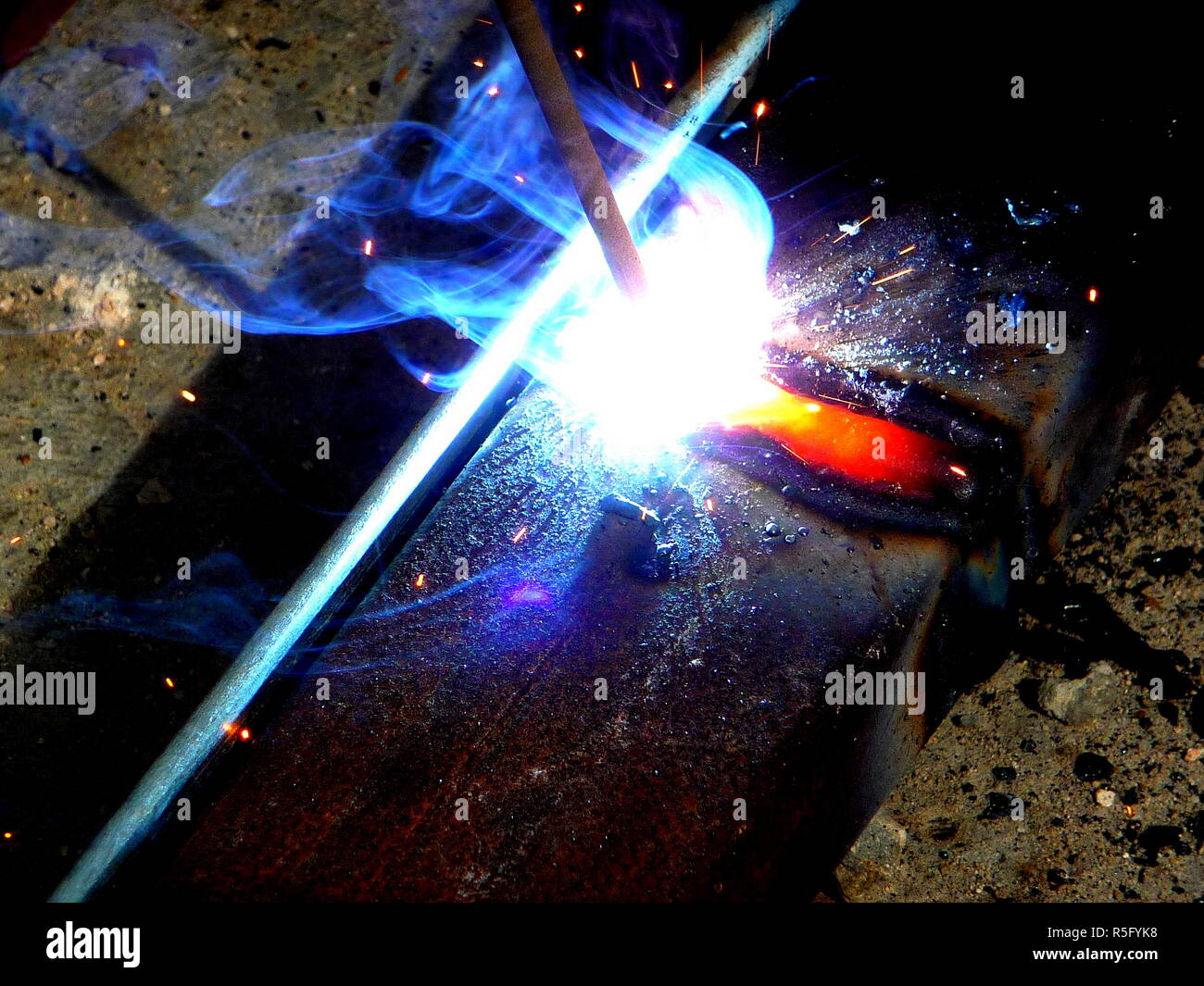 Hot Sparks of fire from steel cutting machines when men are using the ...