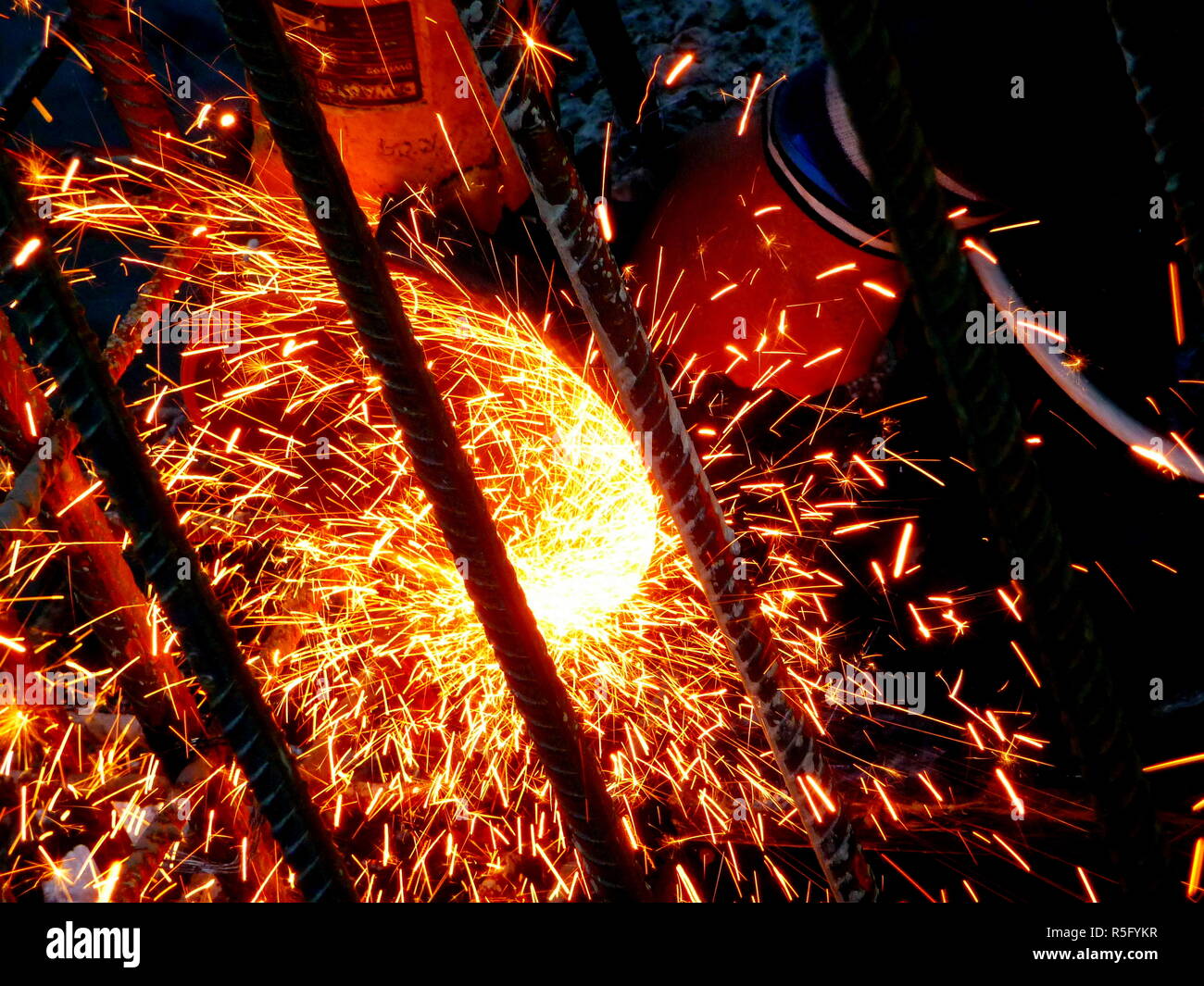 Hot Sparks of fire from steel cutting machines when men are using the ...
