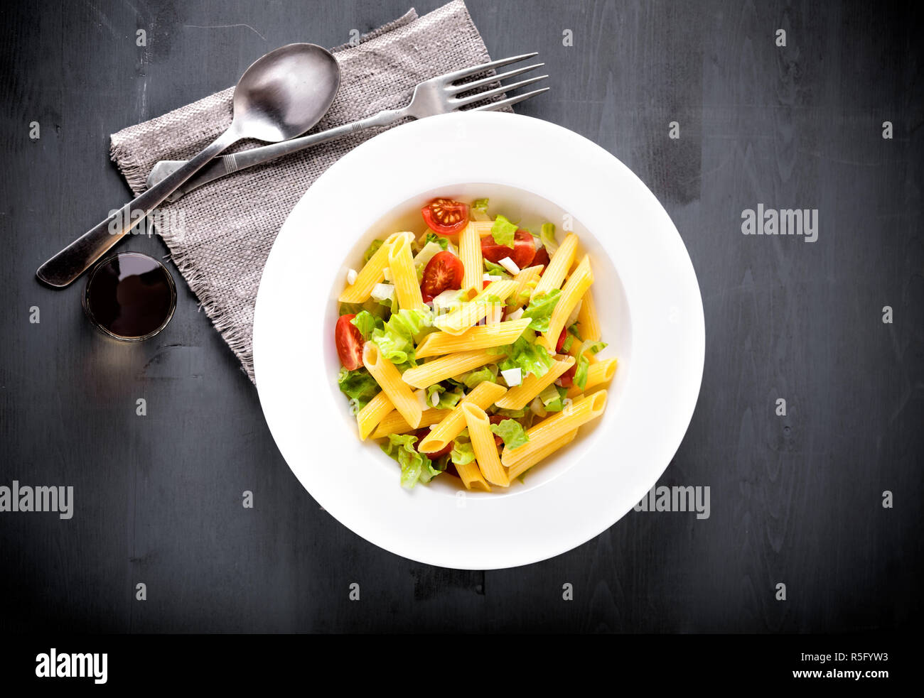 Pasta salad with fresh greenery and tomatos Stock Photo - Alamy