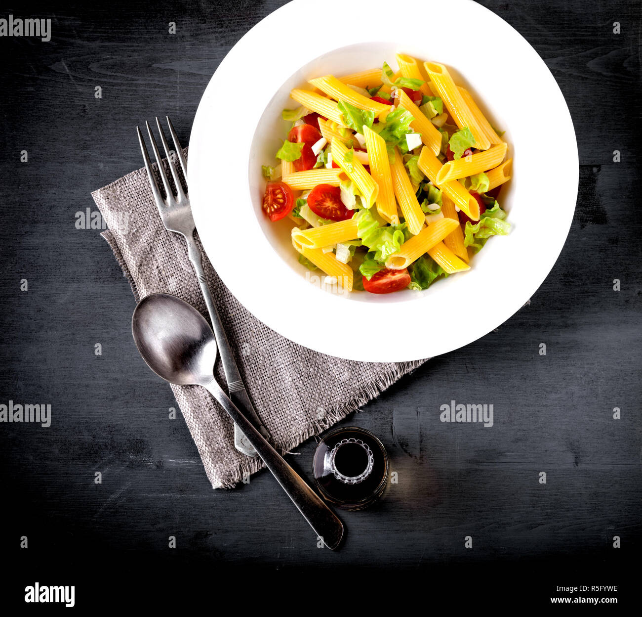 Pasta salad with fresh greenery and tomatos Stock Photo - Alamy