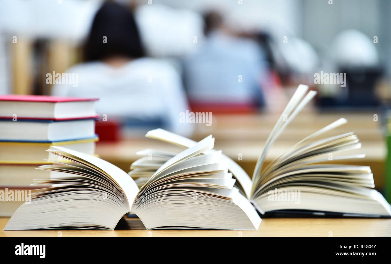 Books lying on the table in the public library Stock Photo - Alamy