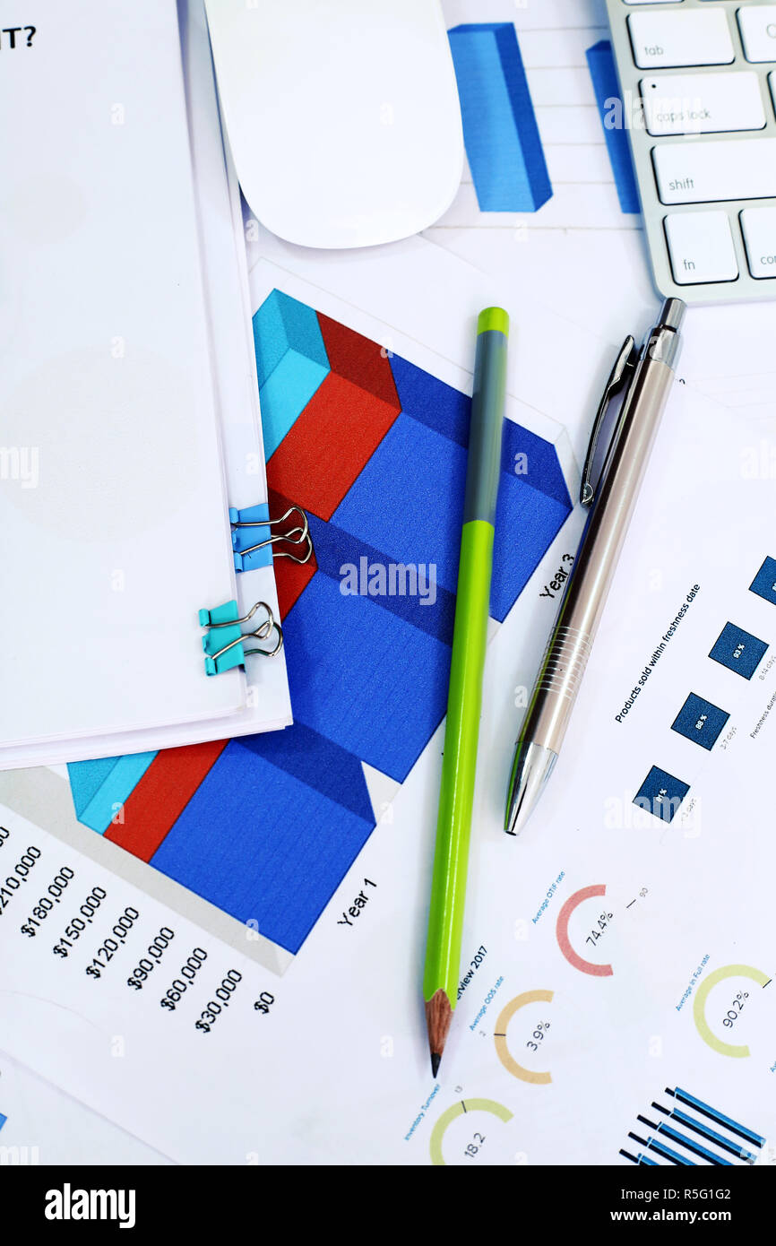 Picture of financial chart paper, pen, pc and pencil Stock Photo - Alamy