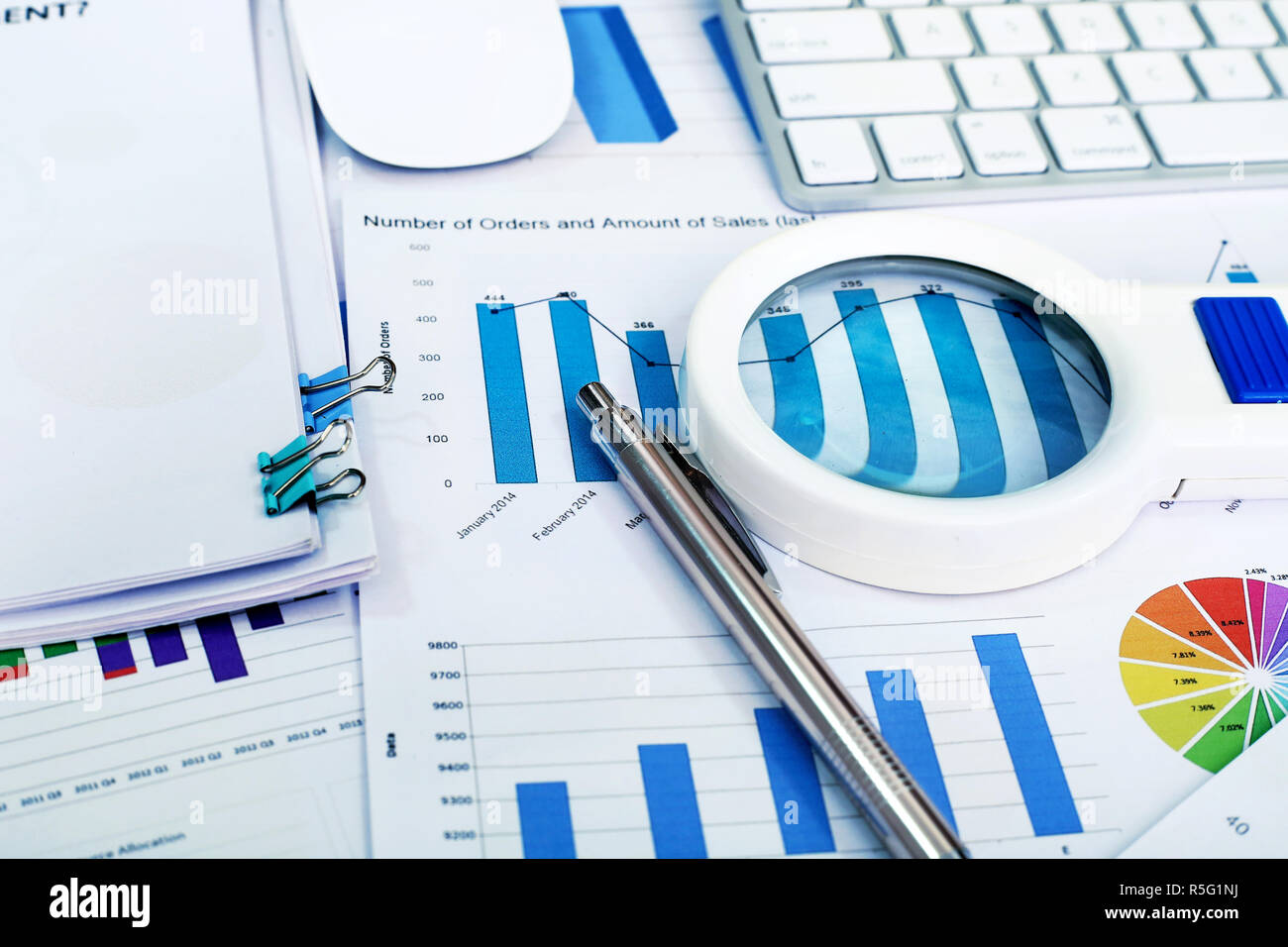 Portrait of chart paper, mouse, keyboard, pen and Magnifying glass ...