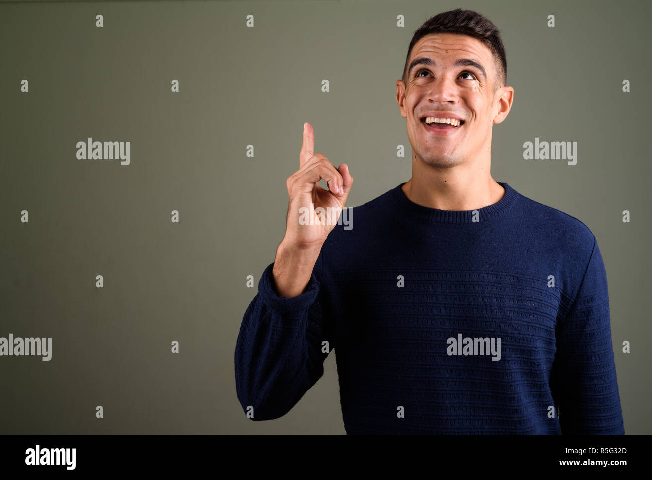 Handsome guy pointing finger up hi-res stock photography and images - Alamy