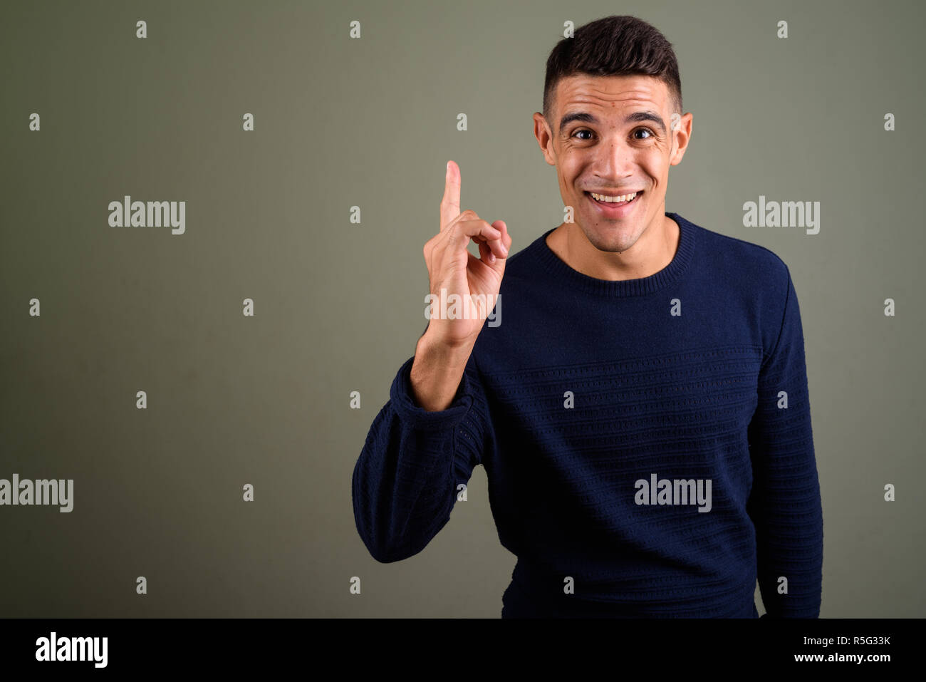 Handsome guy pointing finger up hi-res stock photography and images - Alamy