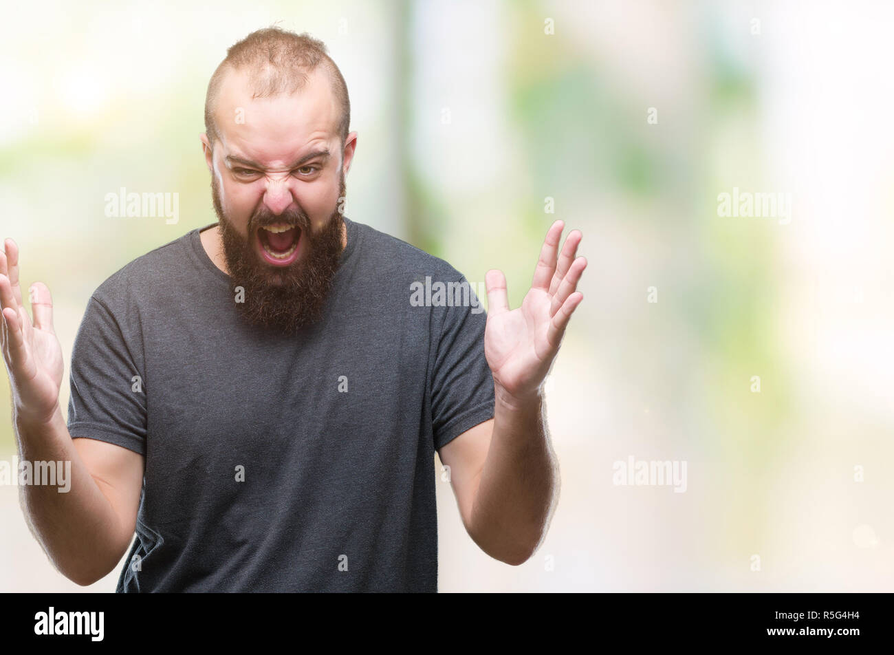 Young caucasian hipster man over isolated background crazy and mad ...