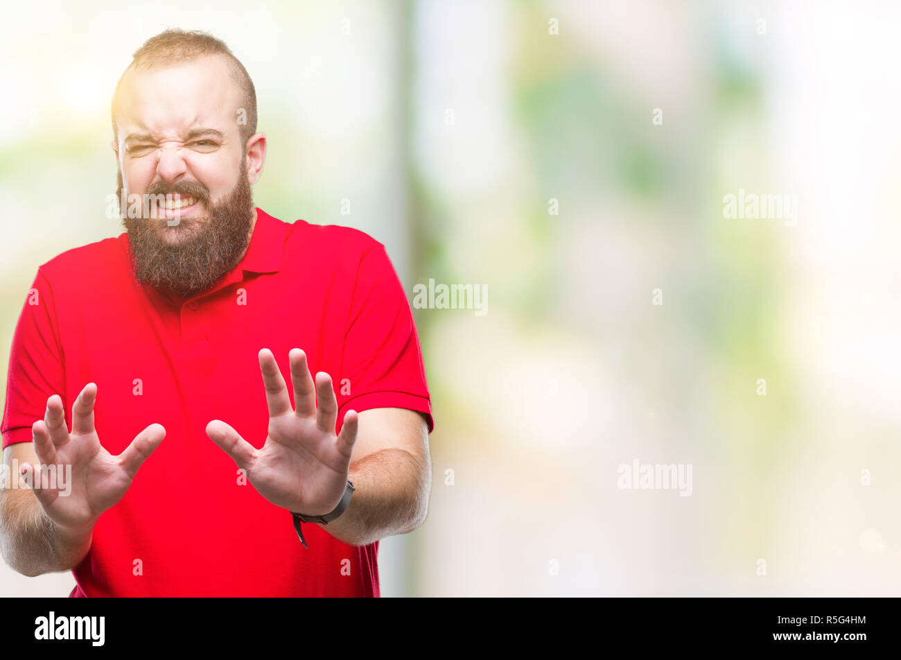 Young caucasian hipster man wearing red shirt over isolated background ...