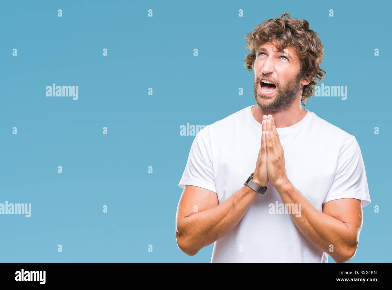 Handsome hispanic model man over isolated background begging and ...