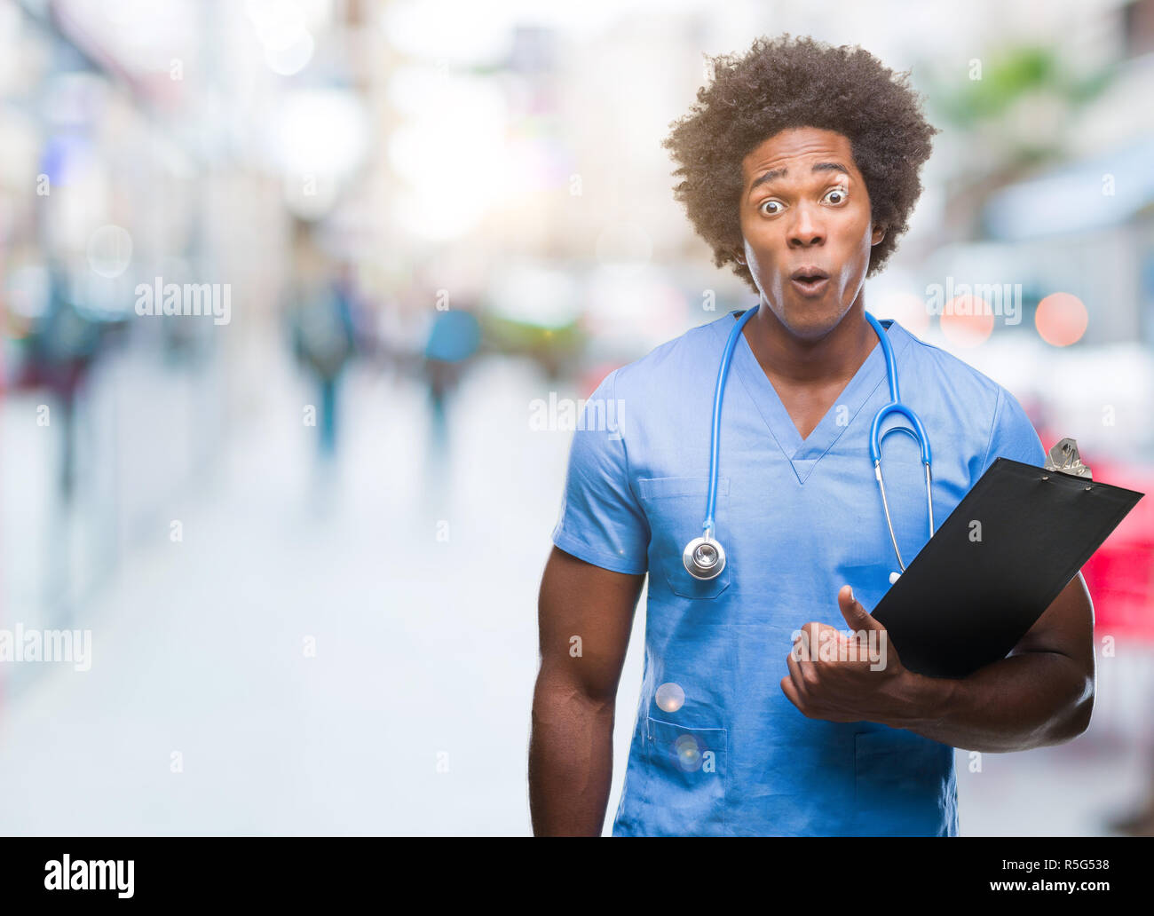 Afro american surgeon doctor holding clipboard man over isolated ...