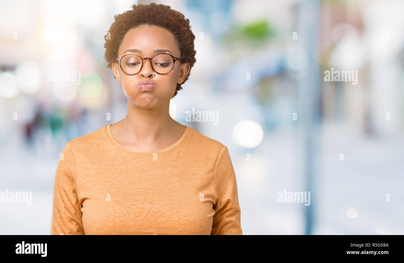 Young beautiful african american woman wearing glasses over isolated ...