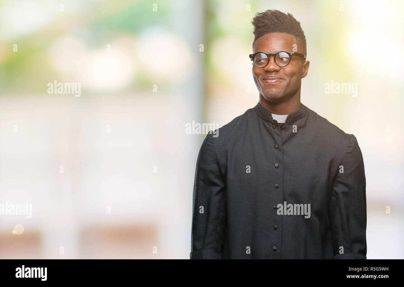 Young african american priest man over isolated background smiling ...