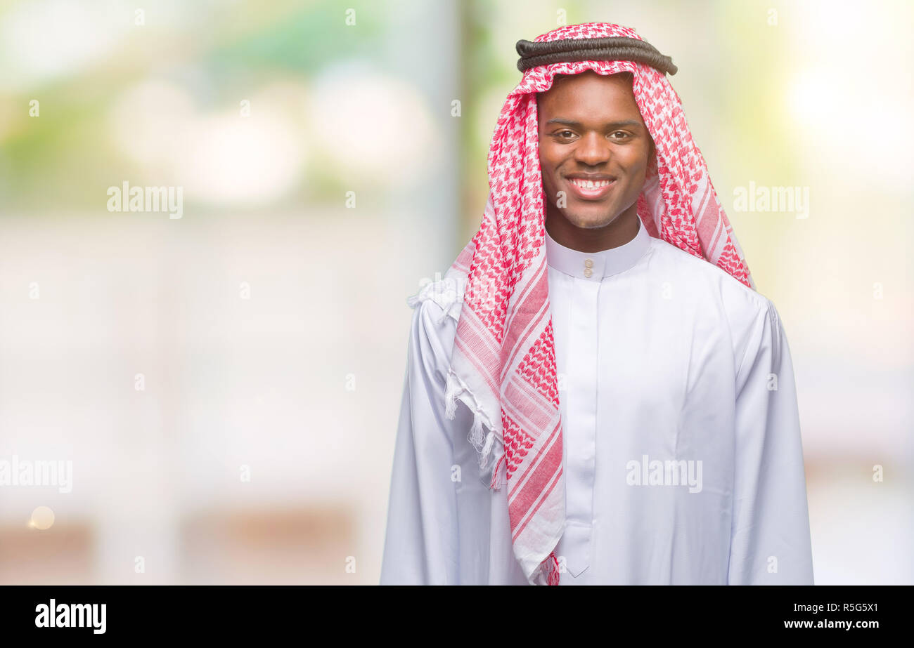 Young arabic african man wearing traditional keffiyeh over isolated ...