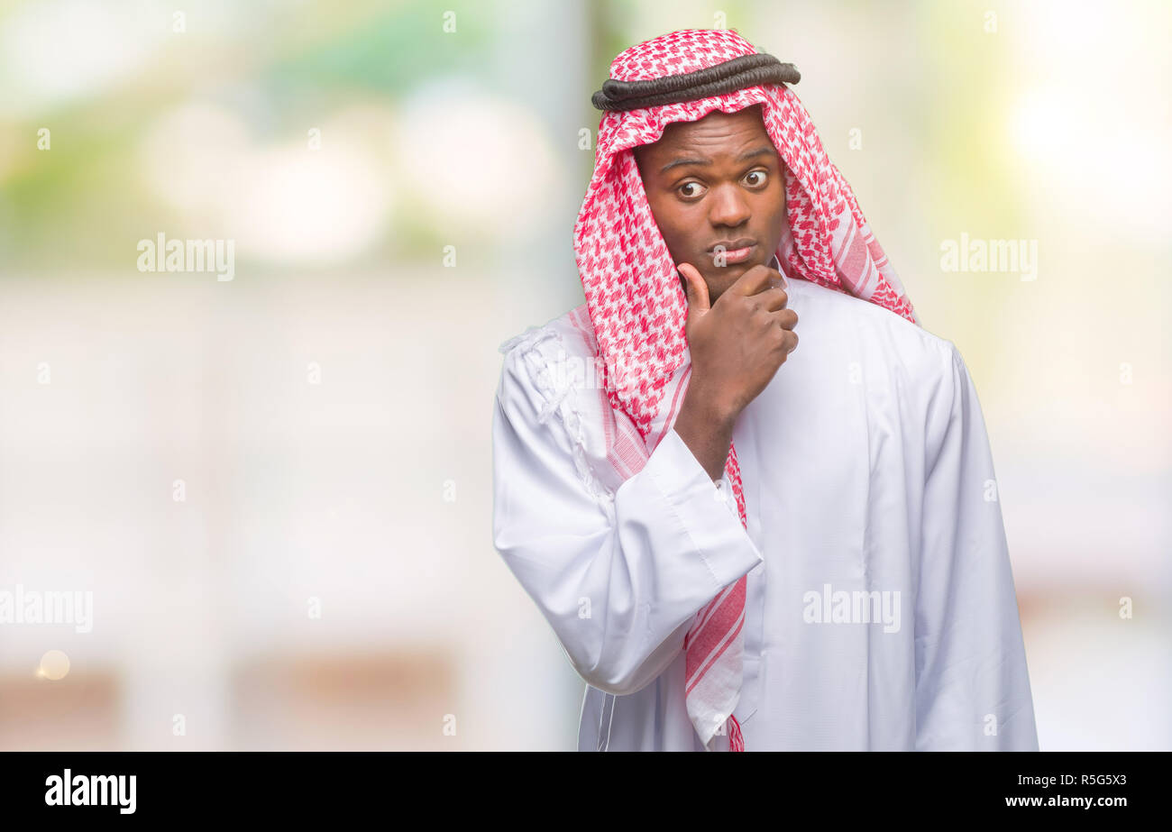 Young arabic african man wearing traditional keffiyeh over isolated ...
