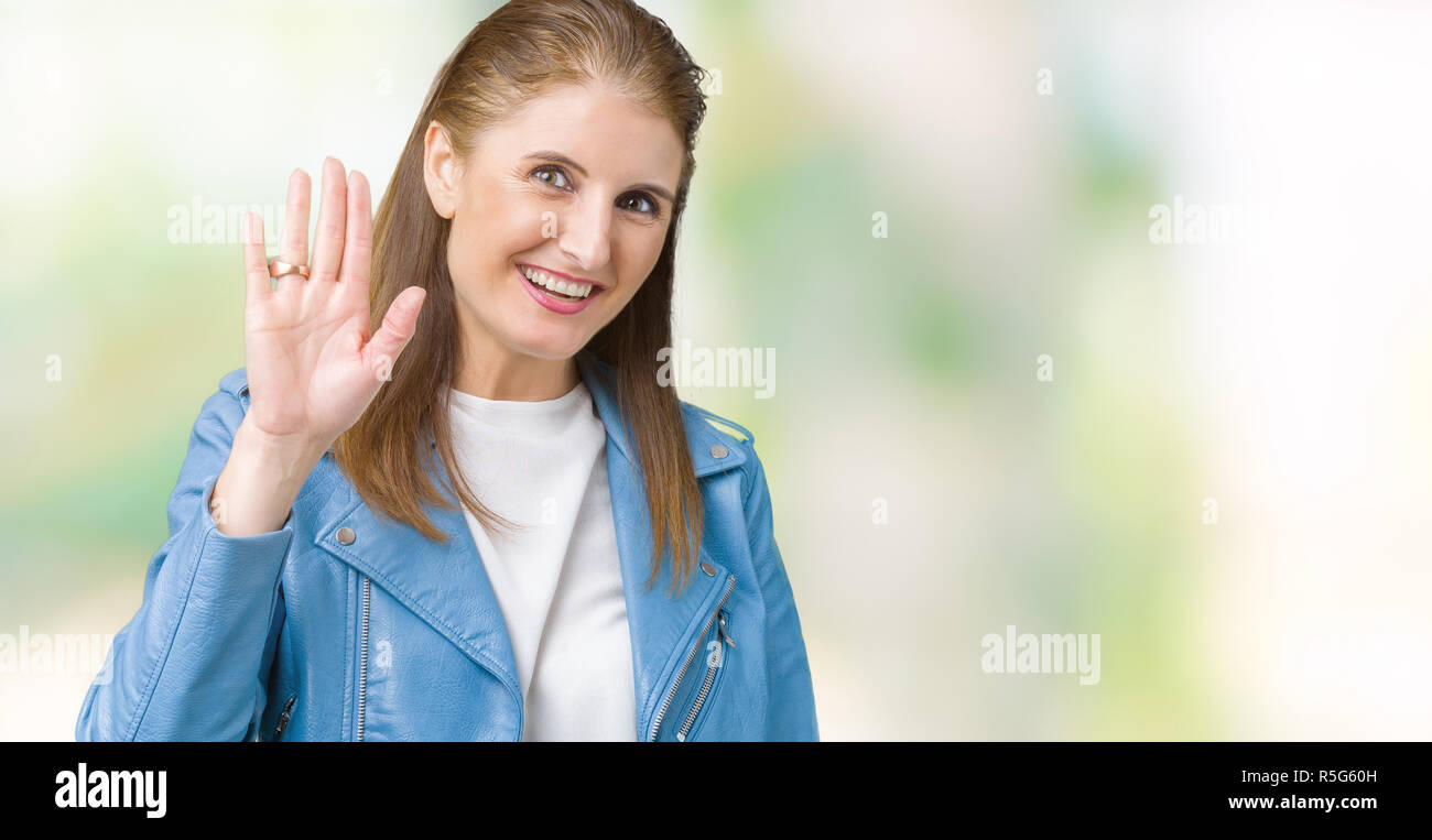 Beautiful middle age mature woman wearing fashion leather jacket over ...