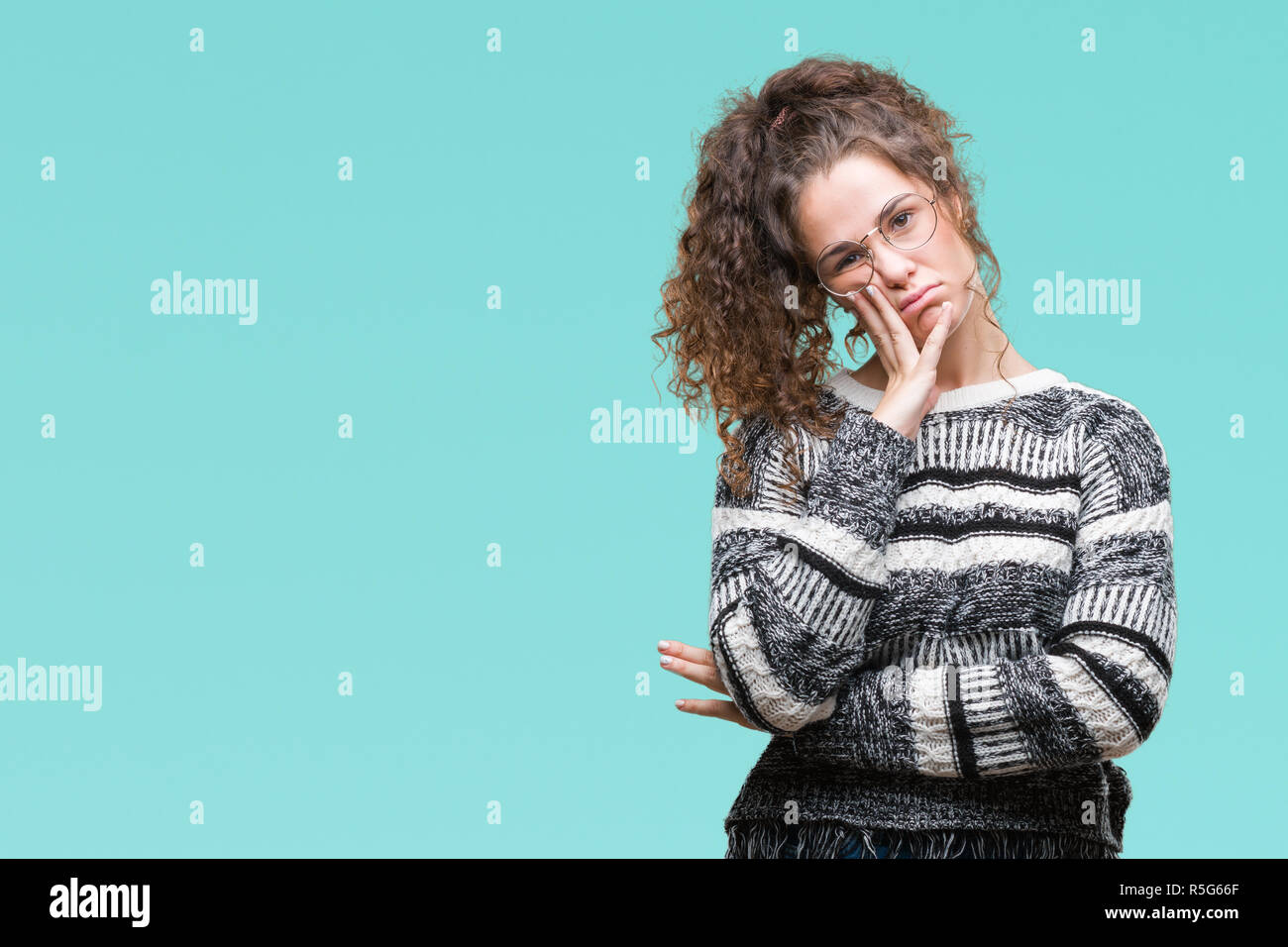 Beautiful brunette curly hair young girl wearing glasses over isolated ...