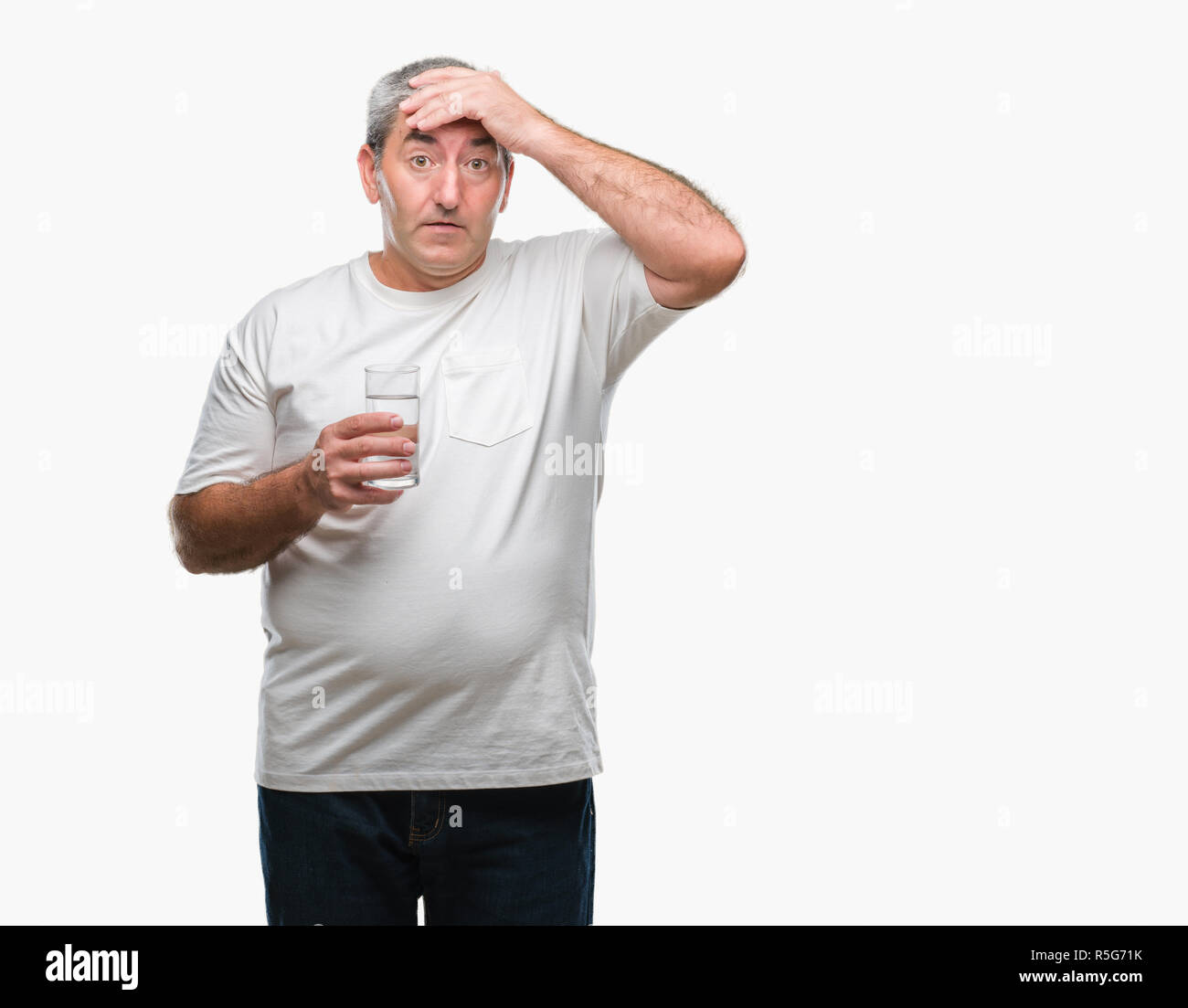Handsome senior man drinking glass of water over isolated background ...