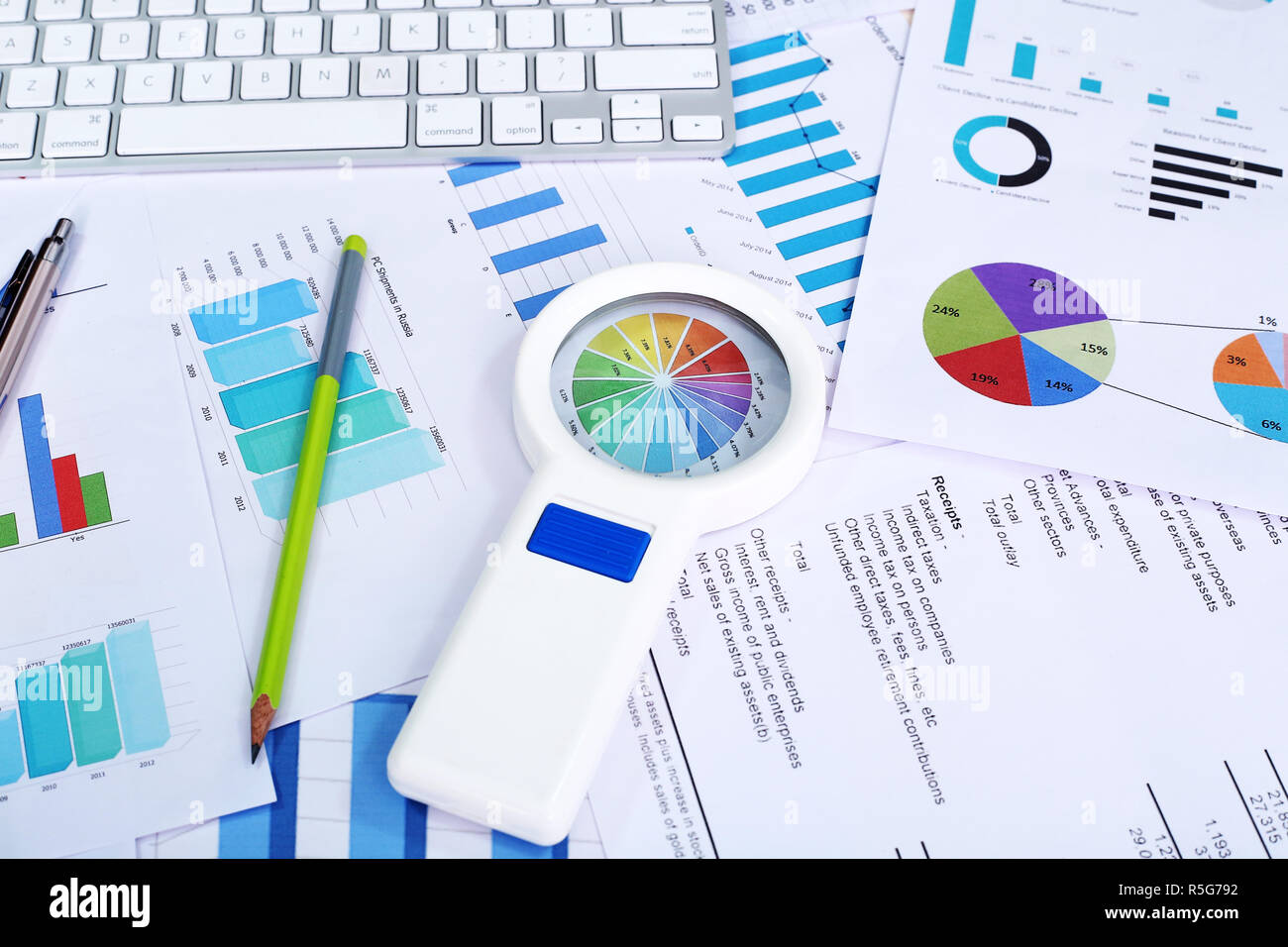 Portrait of pencil, magnifying glass and keyboard on the graph paper ...