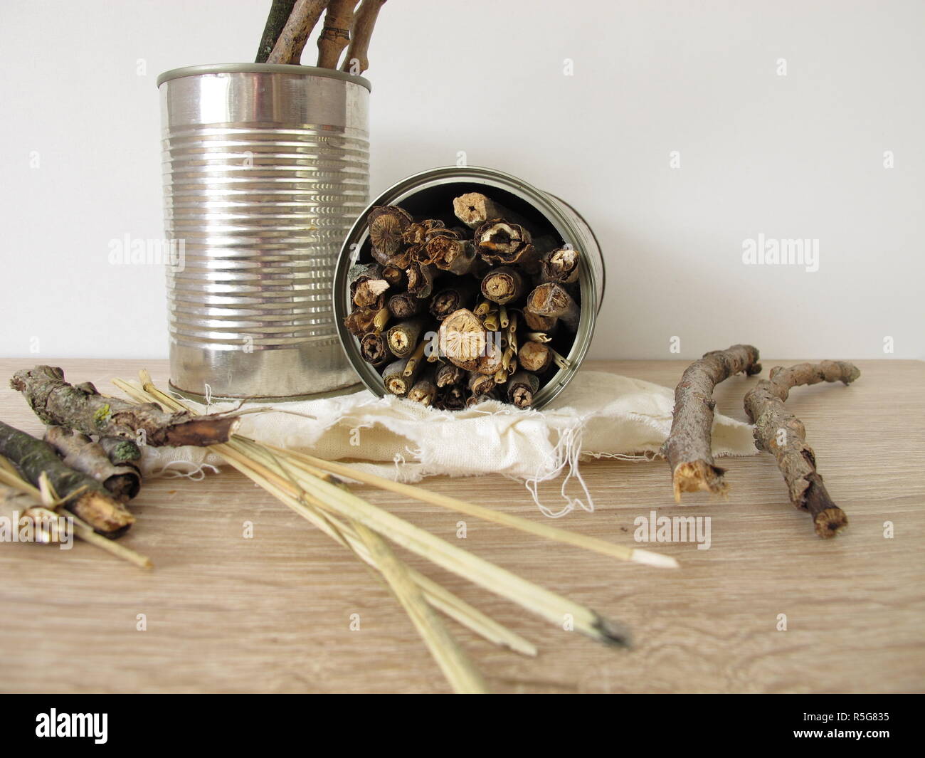 homemade insect hotel made of cans,sticks and straw Stock Photo - Alamy