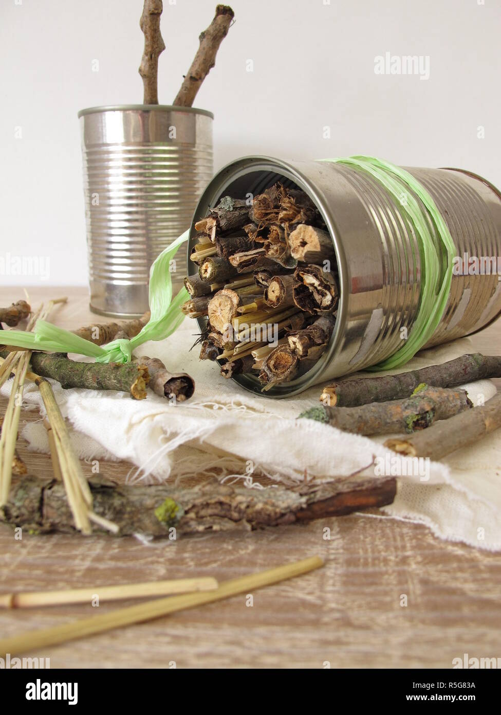 homemade insect hotel made of cans,sticks and straw Stock Photo - Alamy